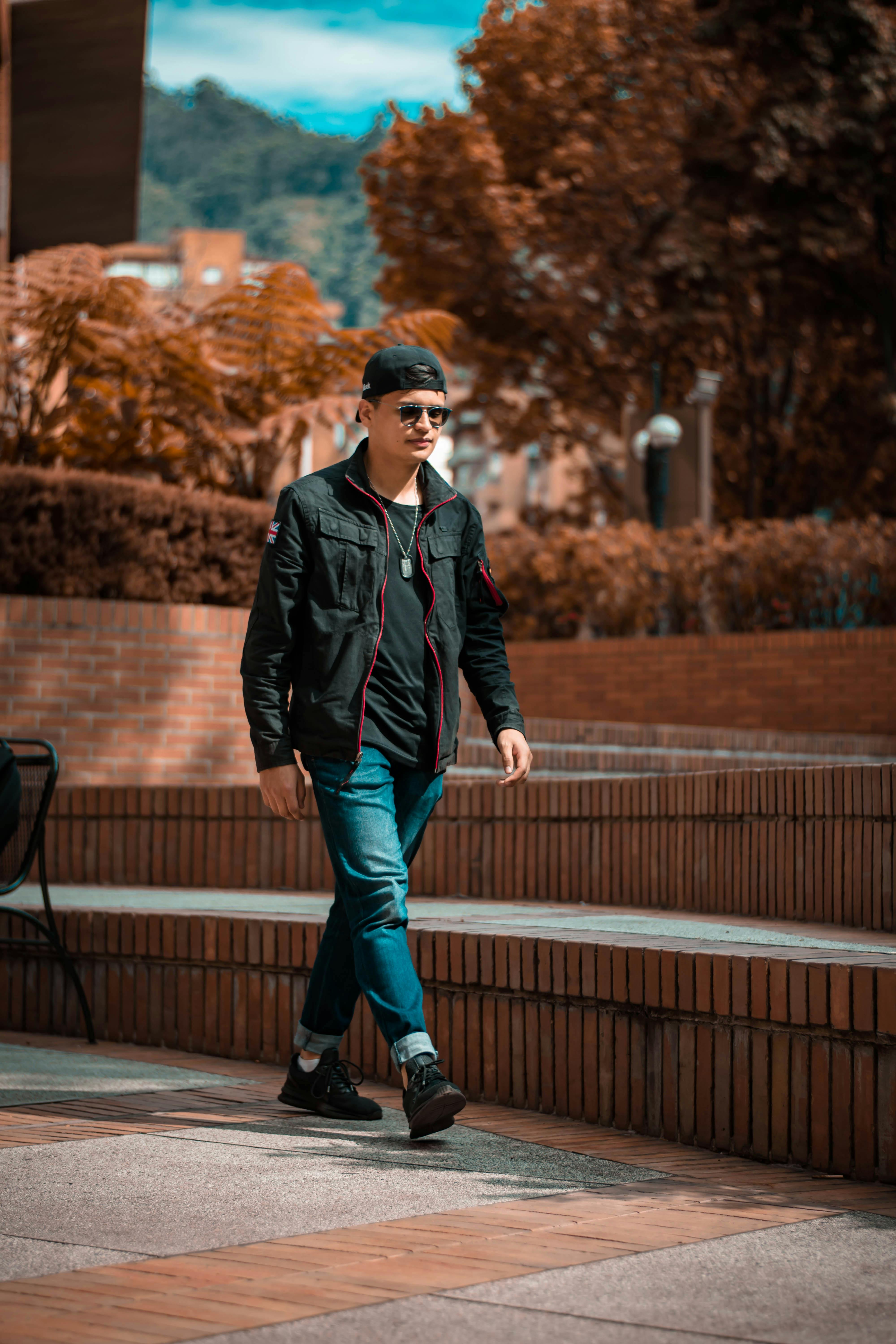 A Man Wearing Hat While Walking · Free Stock Photo