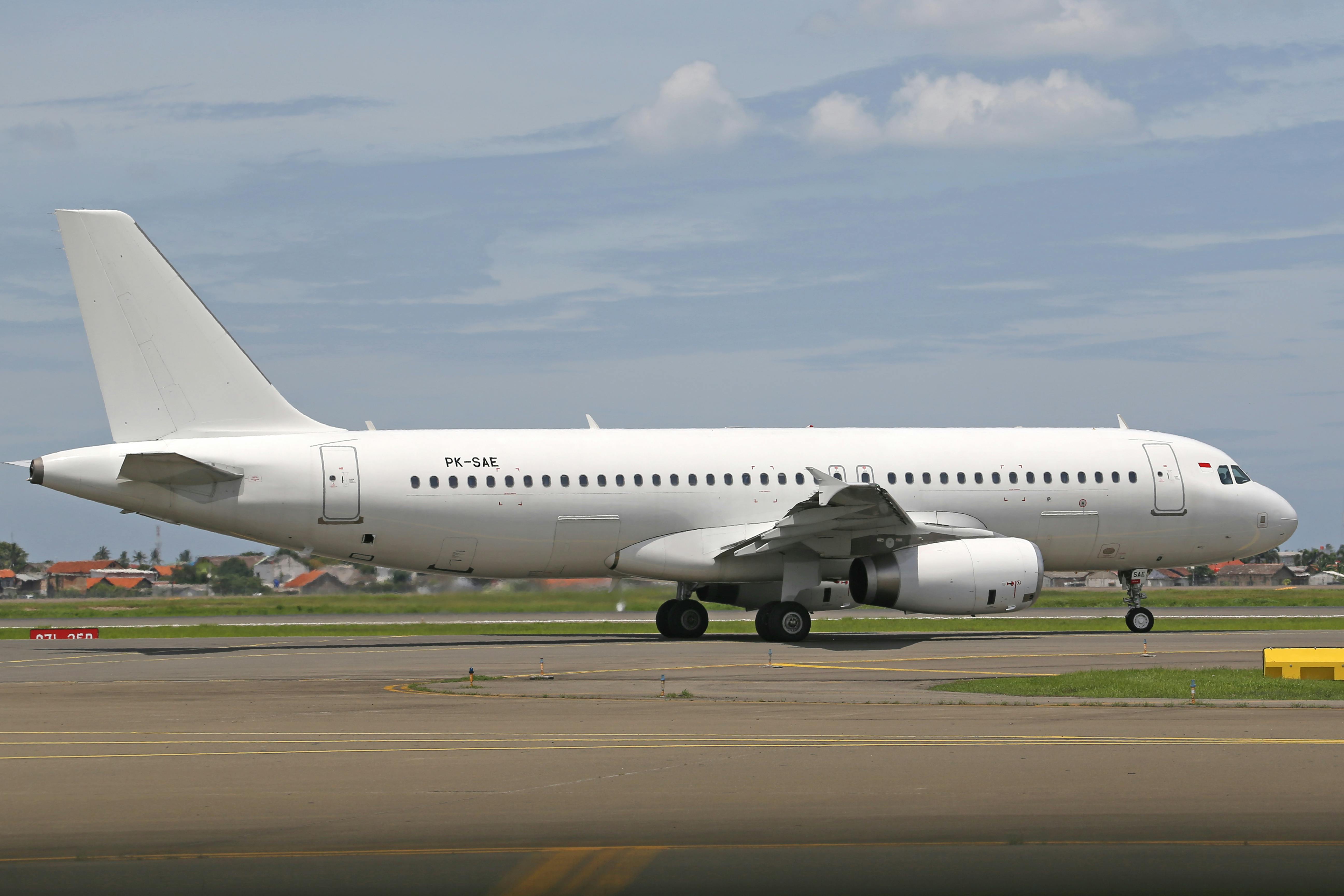 Gray Airplane on Seashore · Free Stock Photo