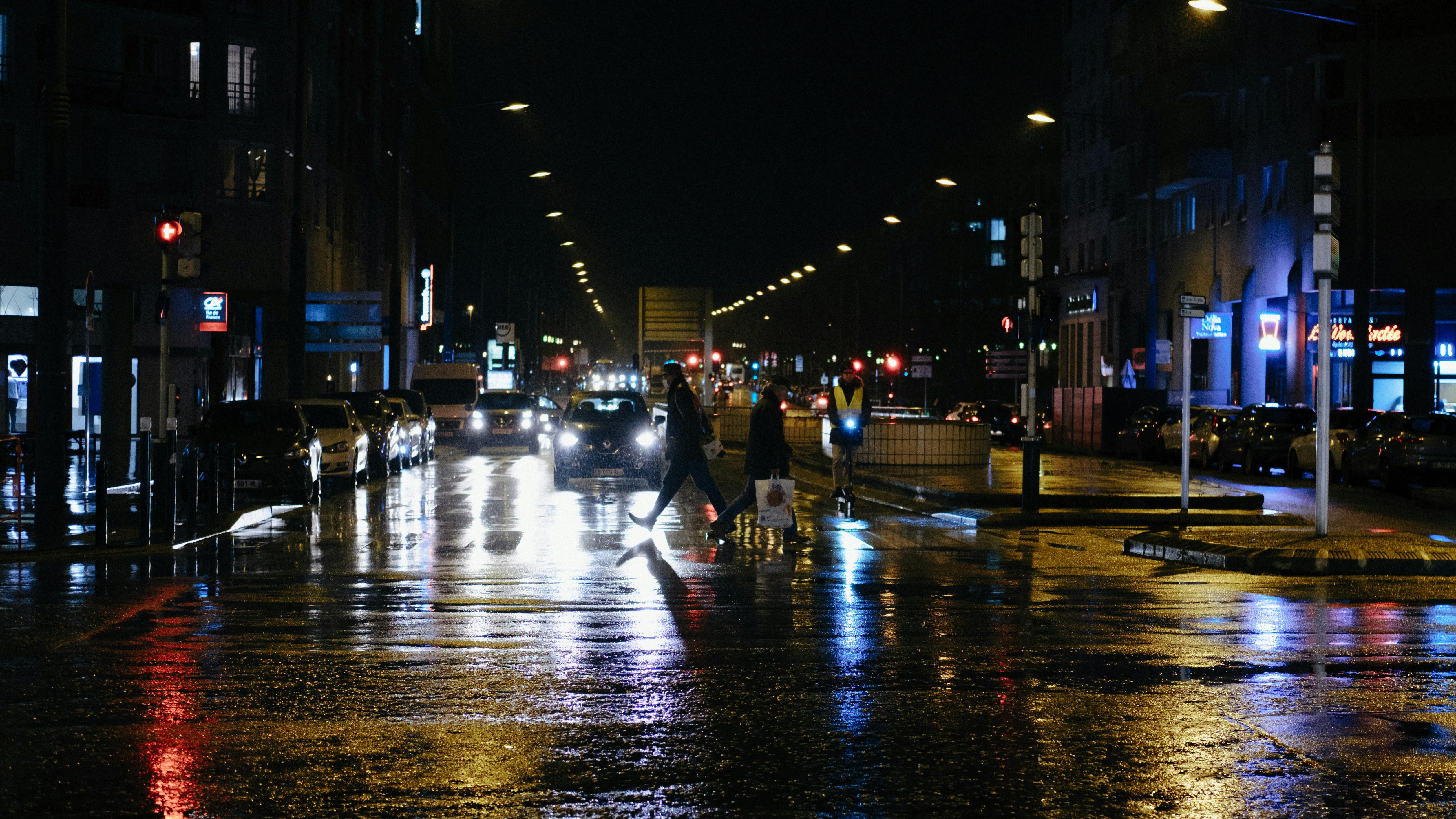 People Crossing the Wet Road during Night Time · Free Stock Photo