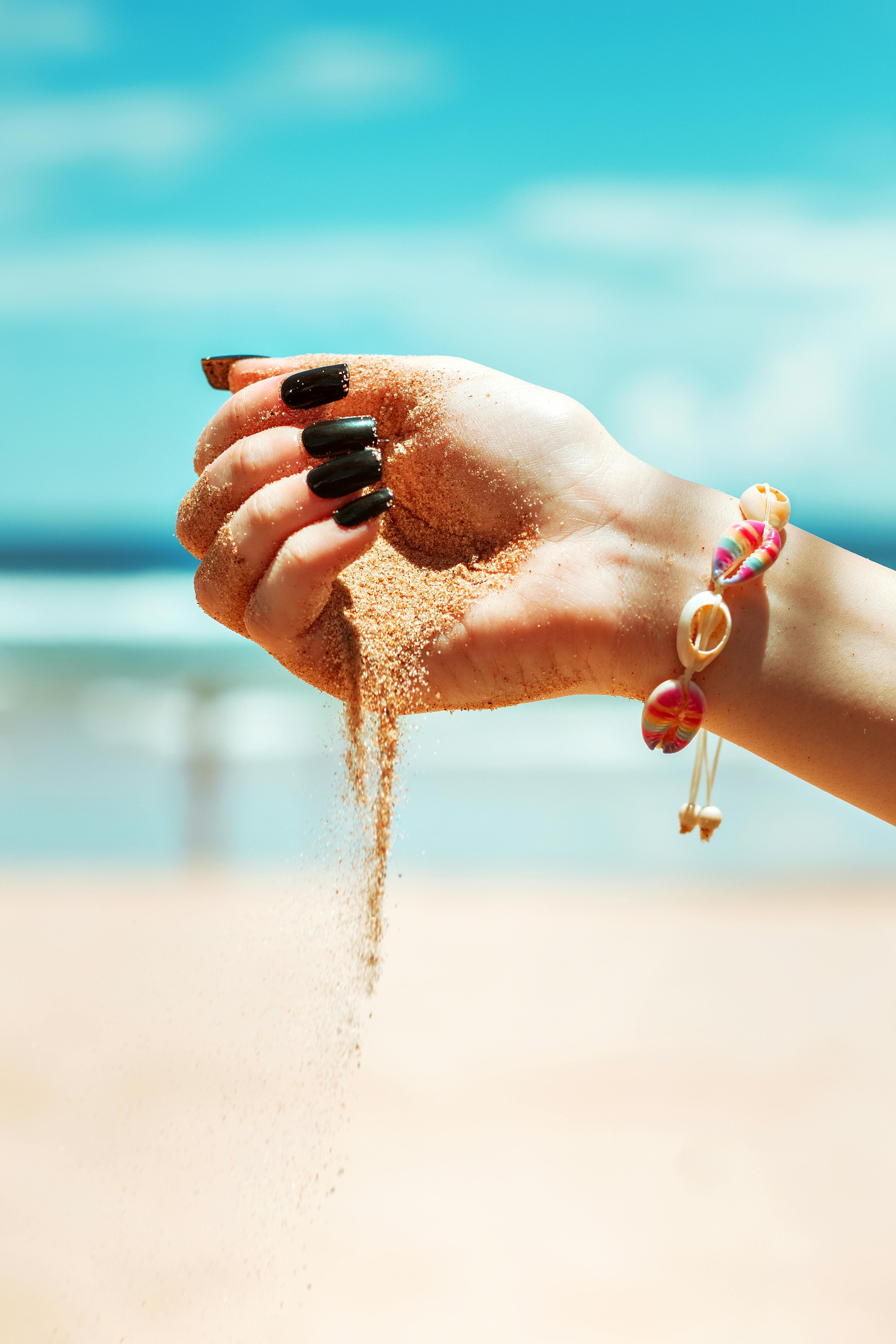 Sand Falling out of a Hand · Free Stock Photo