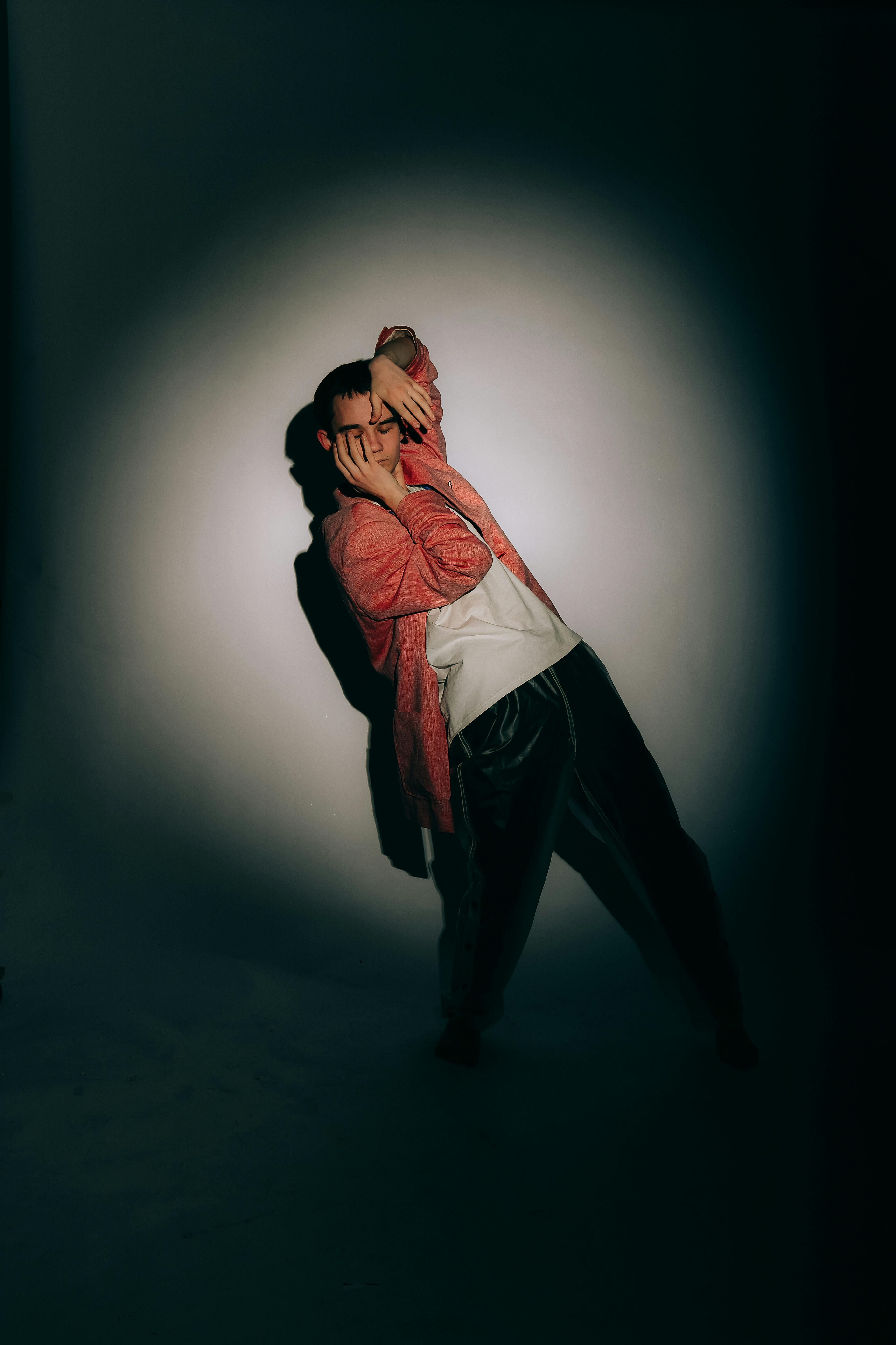 A Woman Holding a Red Hand Fan · Free Stock Photo