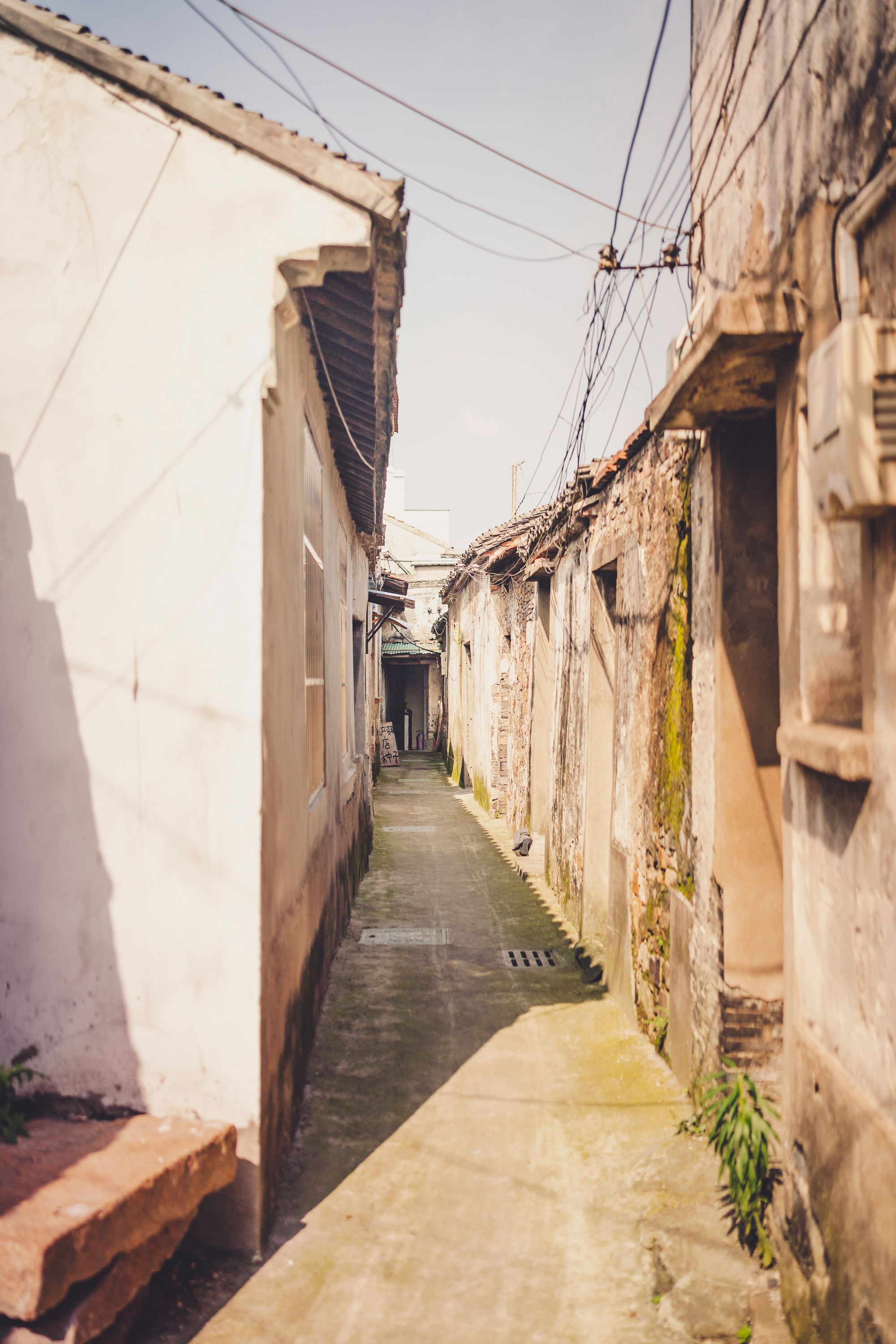 An Empty Alley Between Concrete Buildings · Free Stock Photo