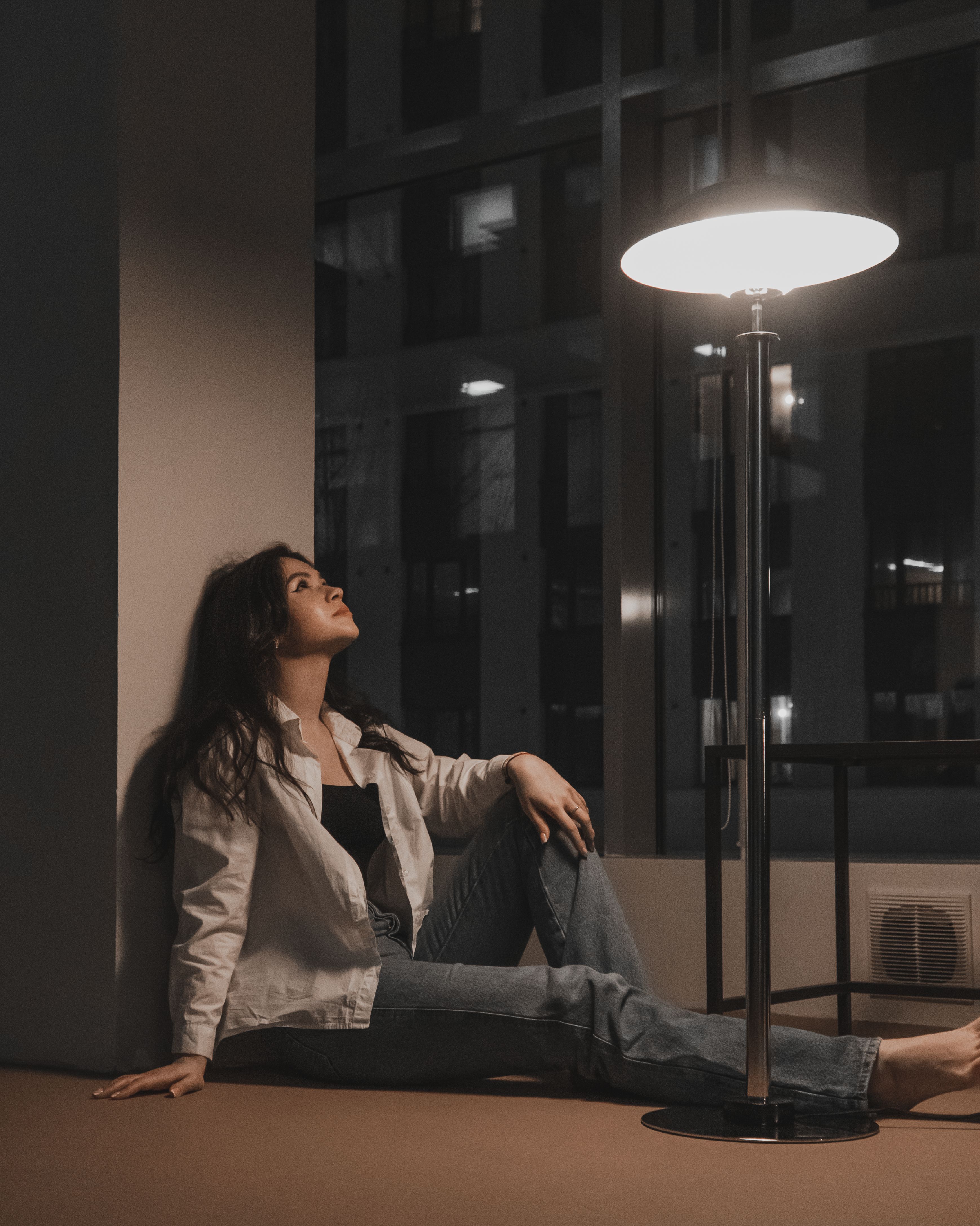 Woman Sitting Beside Table with Lighted Lamp · Free Stock Photo