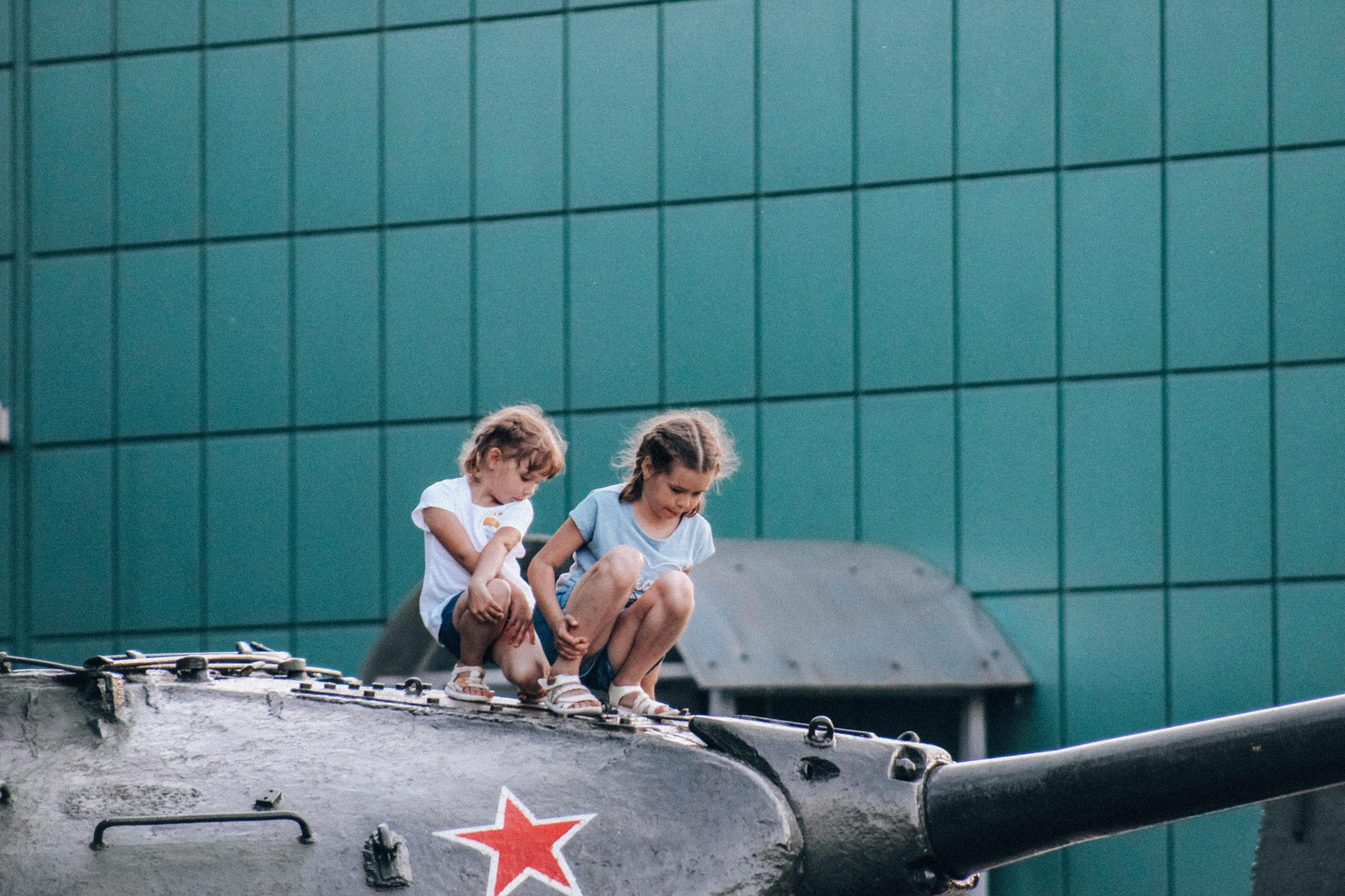 Children Sitting on a Military Tank · Free Stock Photo