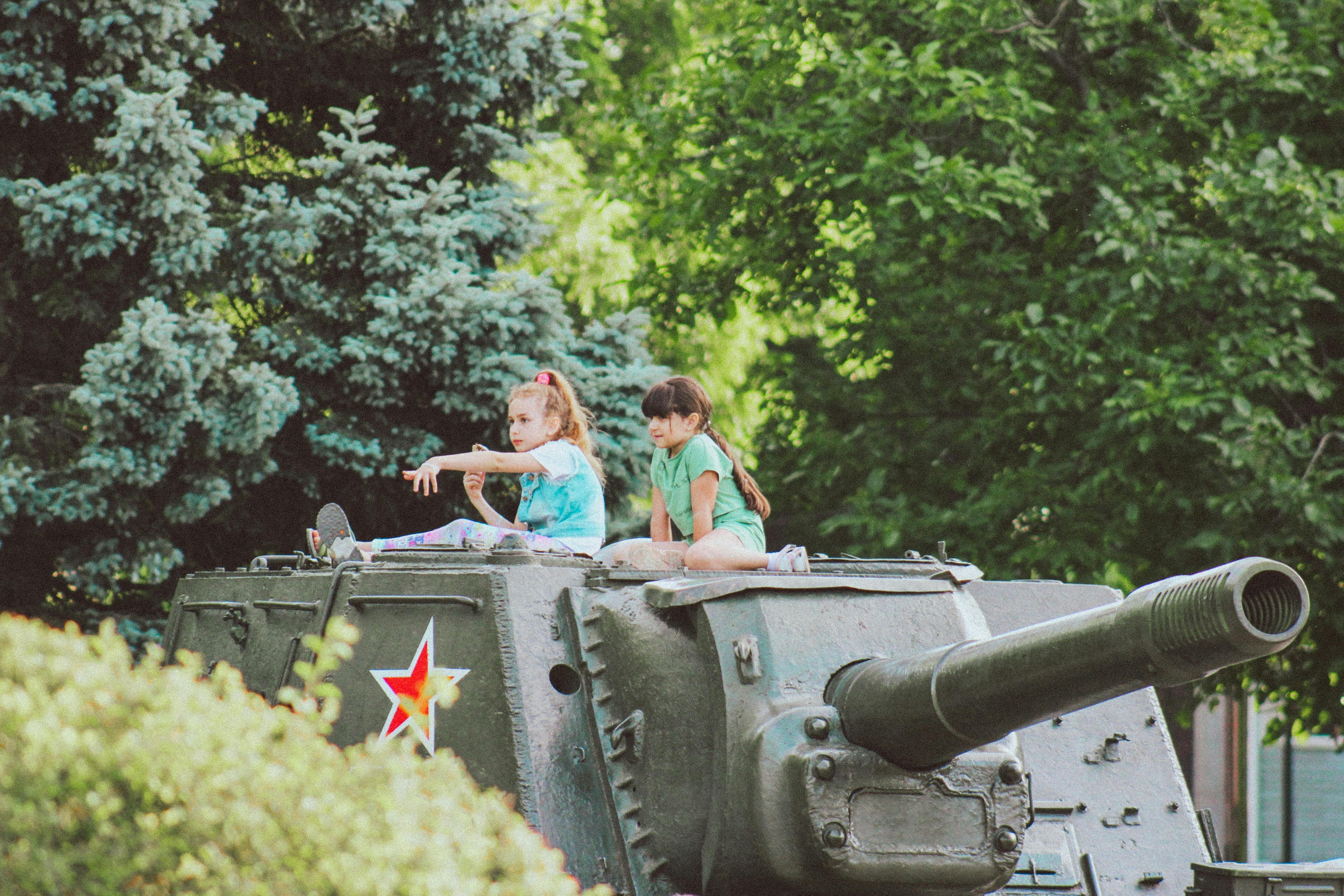 Children Sitting on Top of Military Battle Tank · Free Stock Photo