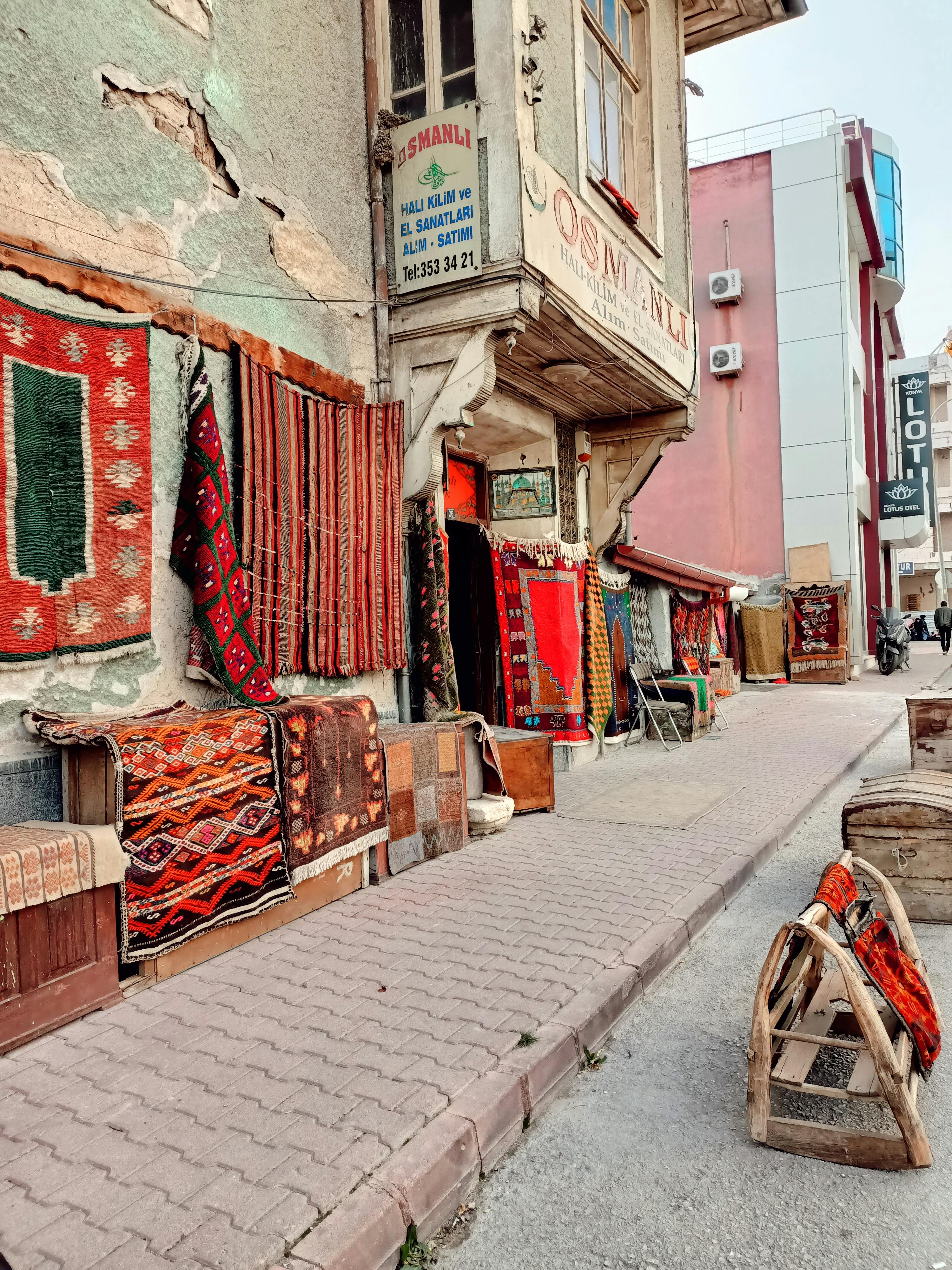 Store Displaying Traditional Rugs on the Sidewalk · Free Stock Photo