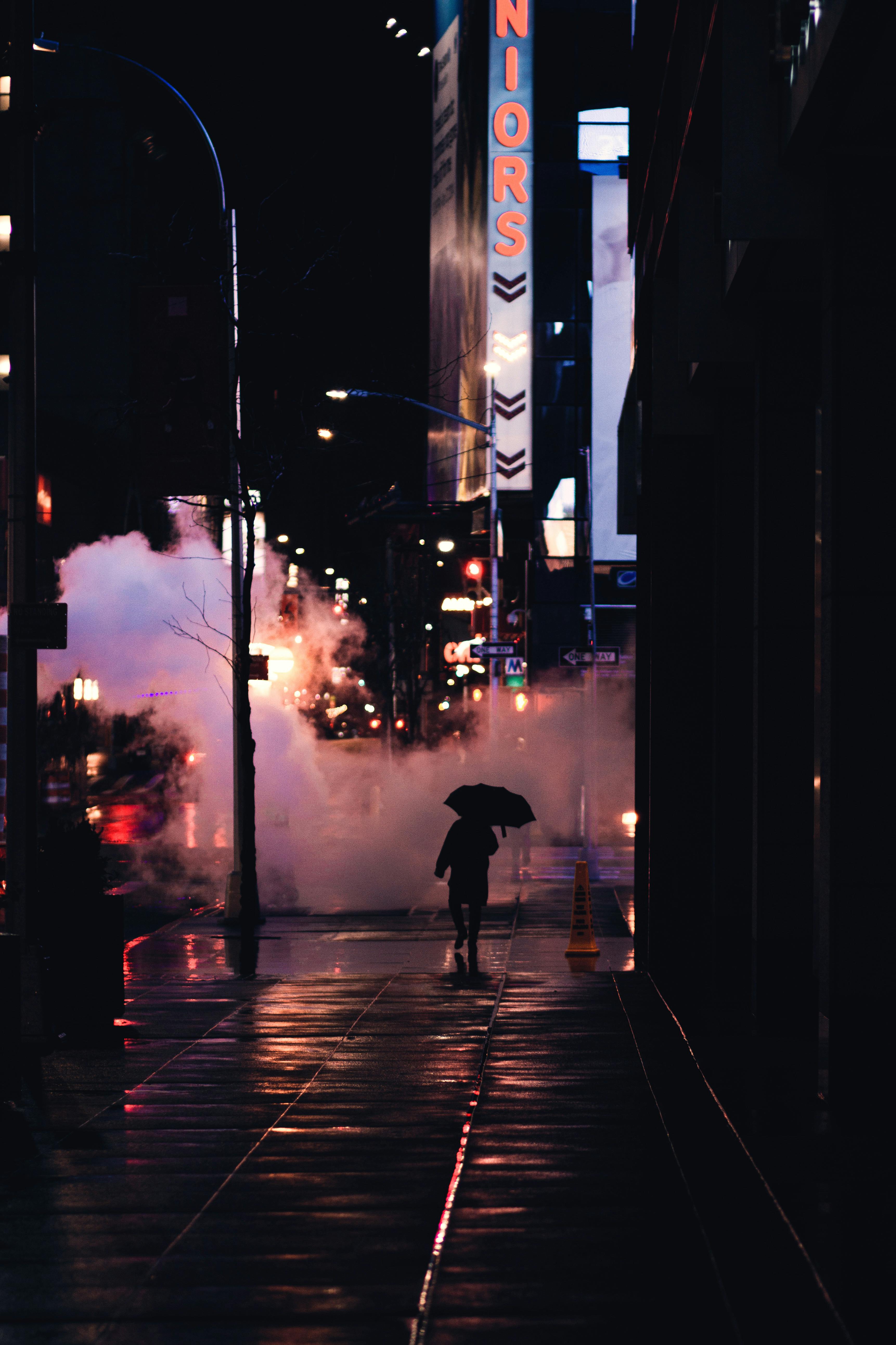Man Standing in Front of Street Light Turned on · Free Stock Photo