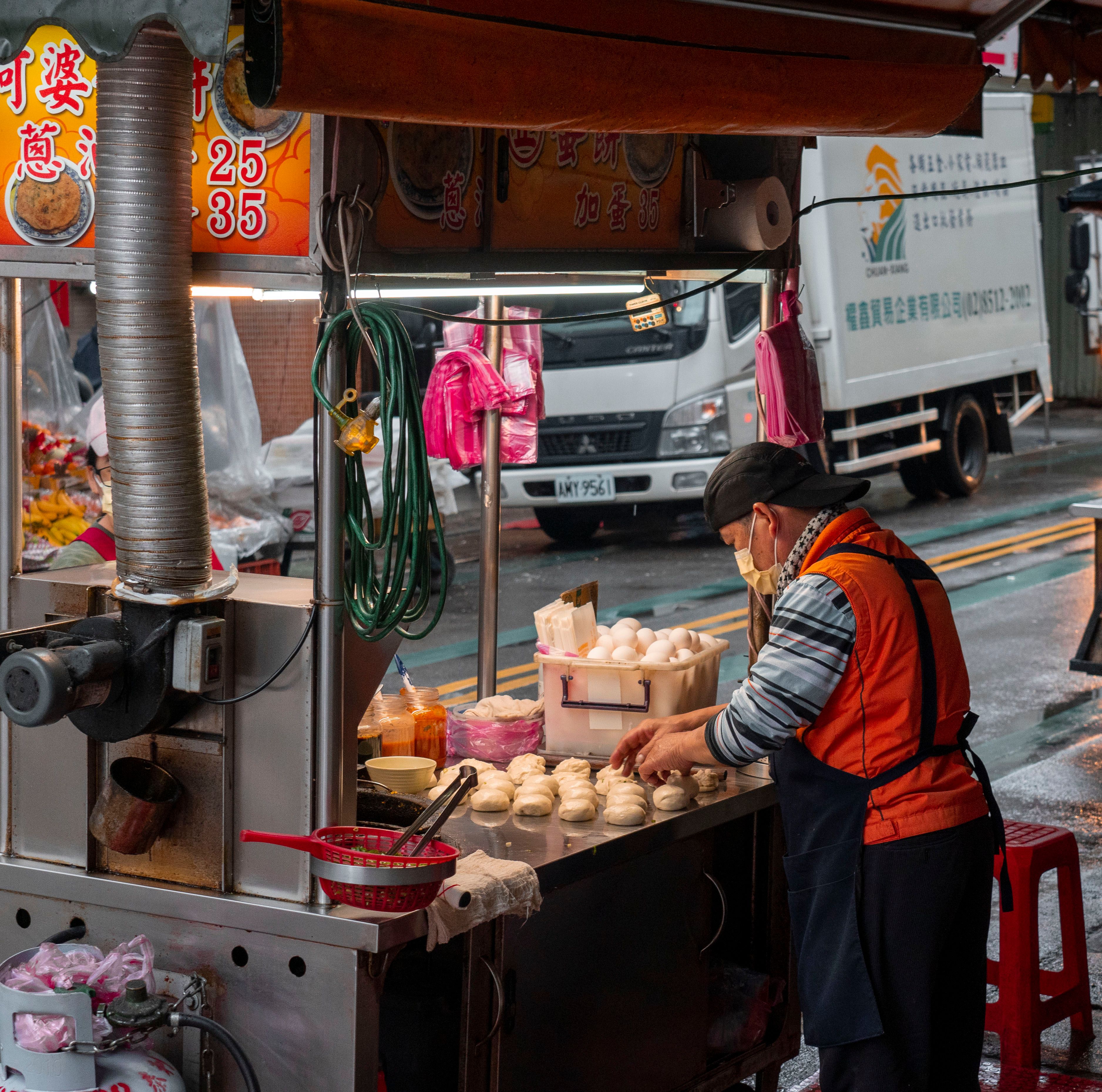 Street Food Stall next to Restaurant at Night · Free Stock Photo