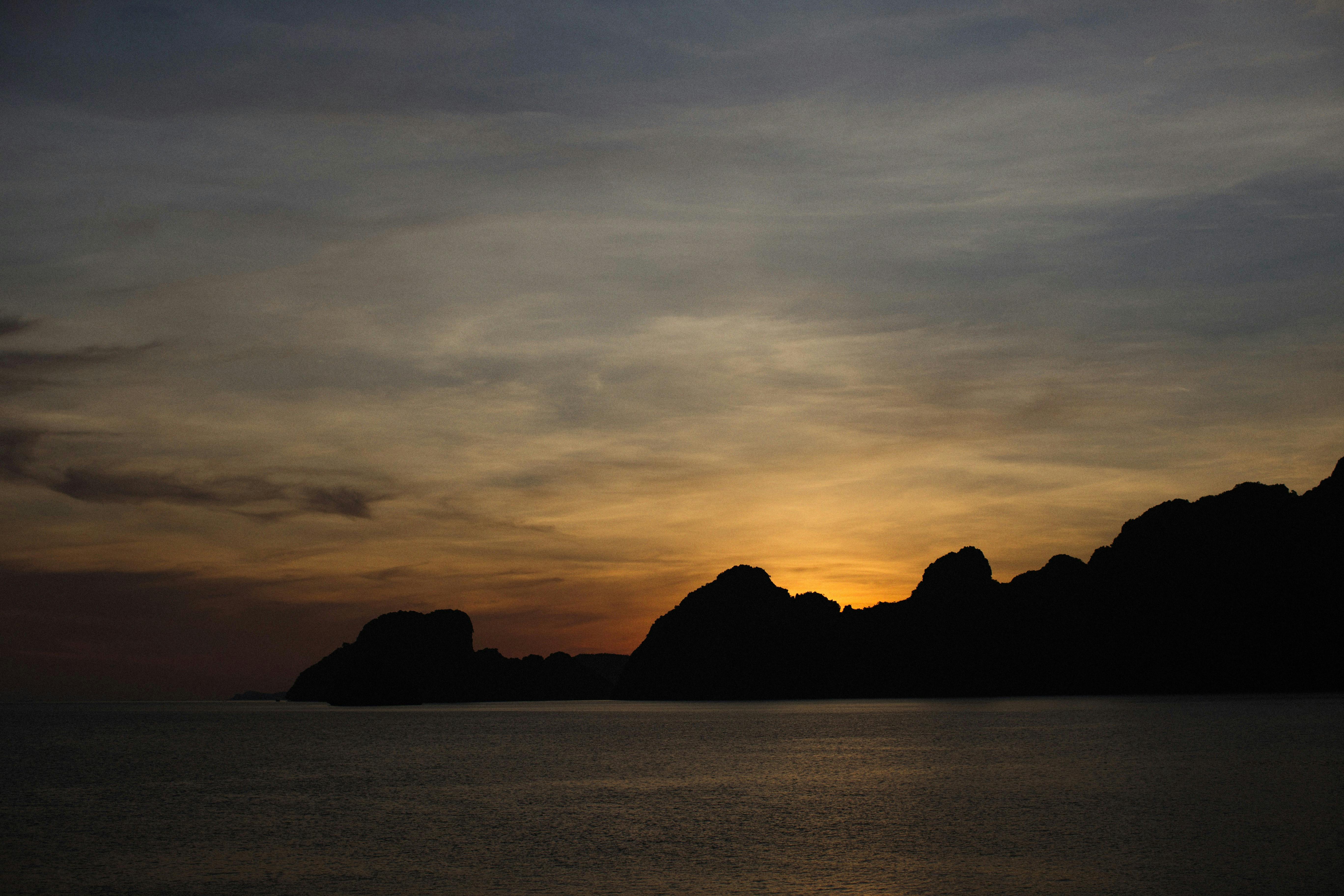 Dramatic Sunset above Rocks in Sea · Free Stock Photo