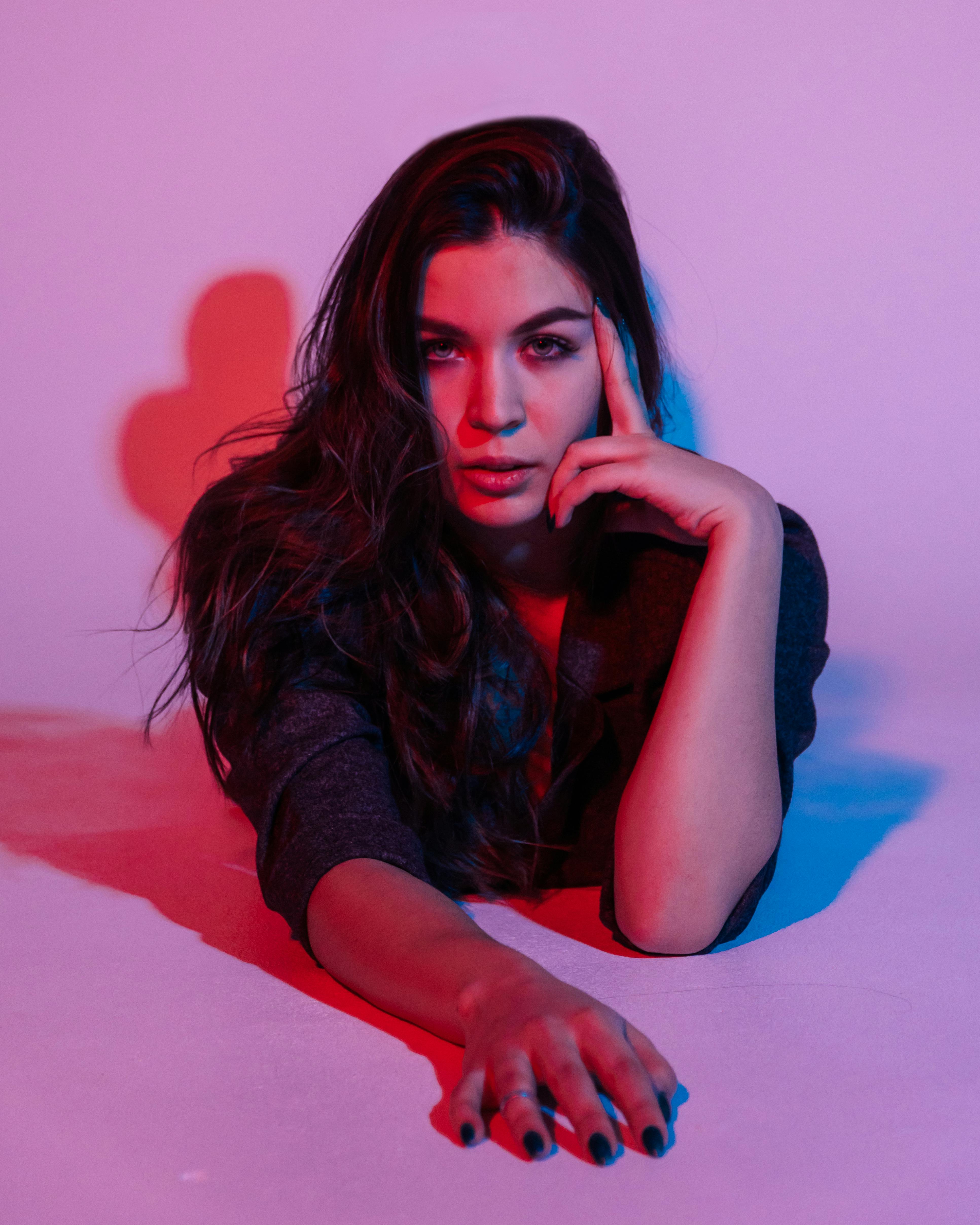 A Woman Posing while Lying on the Floor · Free Stock Photo