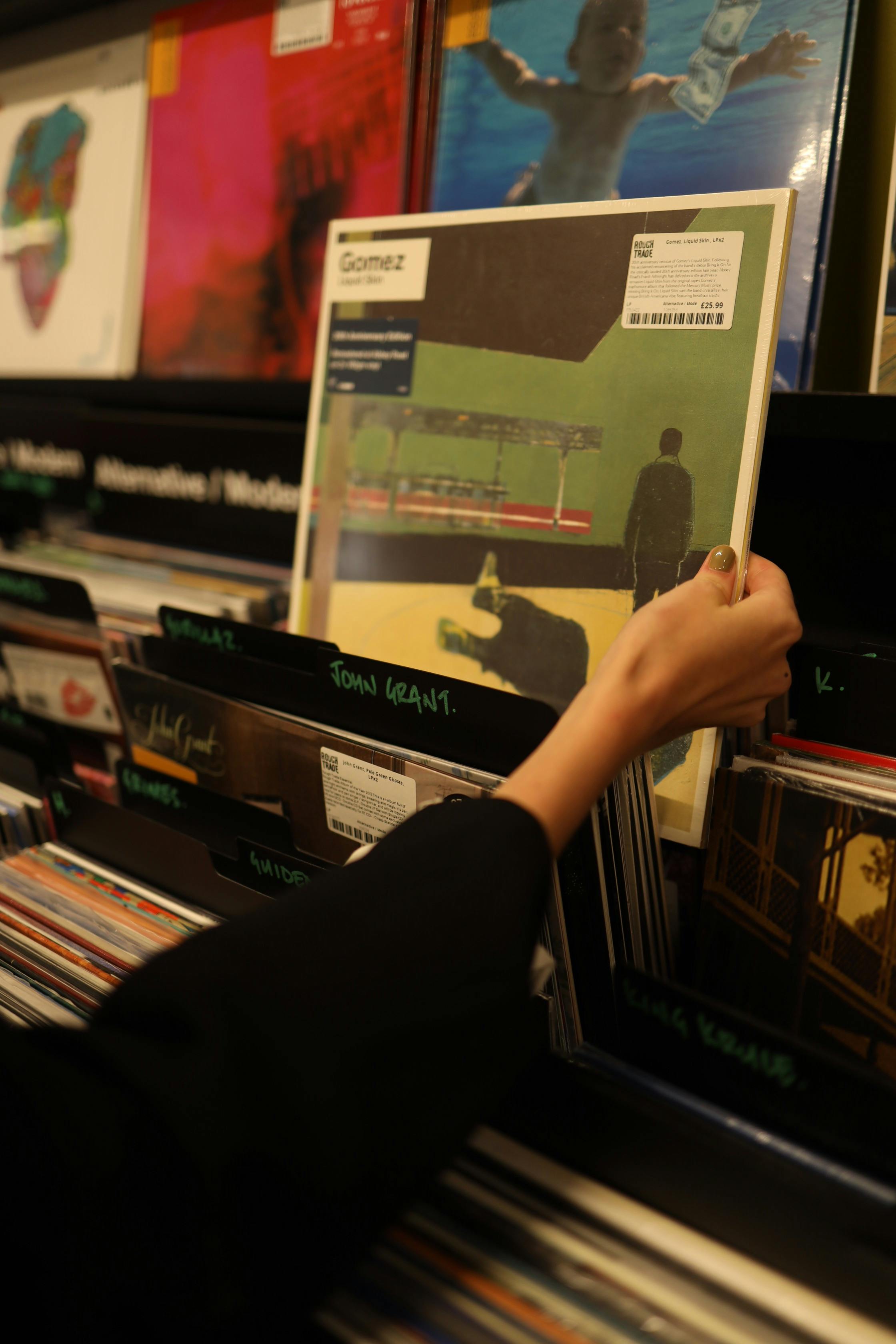 Photo of a Person's Hand Holding a Vinyl Record · Free Stock Photo