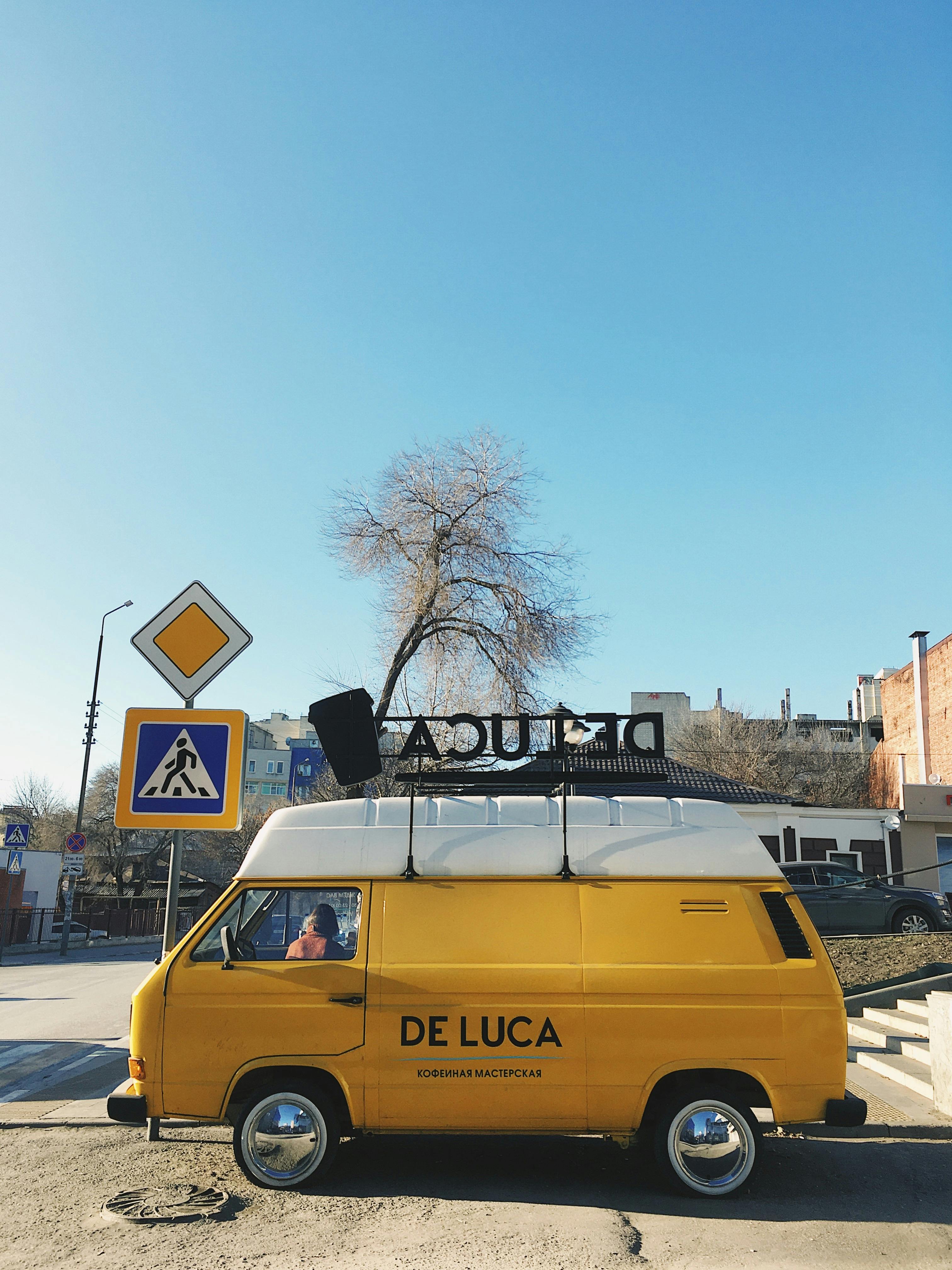 Photo of a Yellow Van on the Road · Free Stock Photo