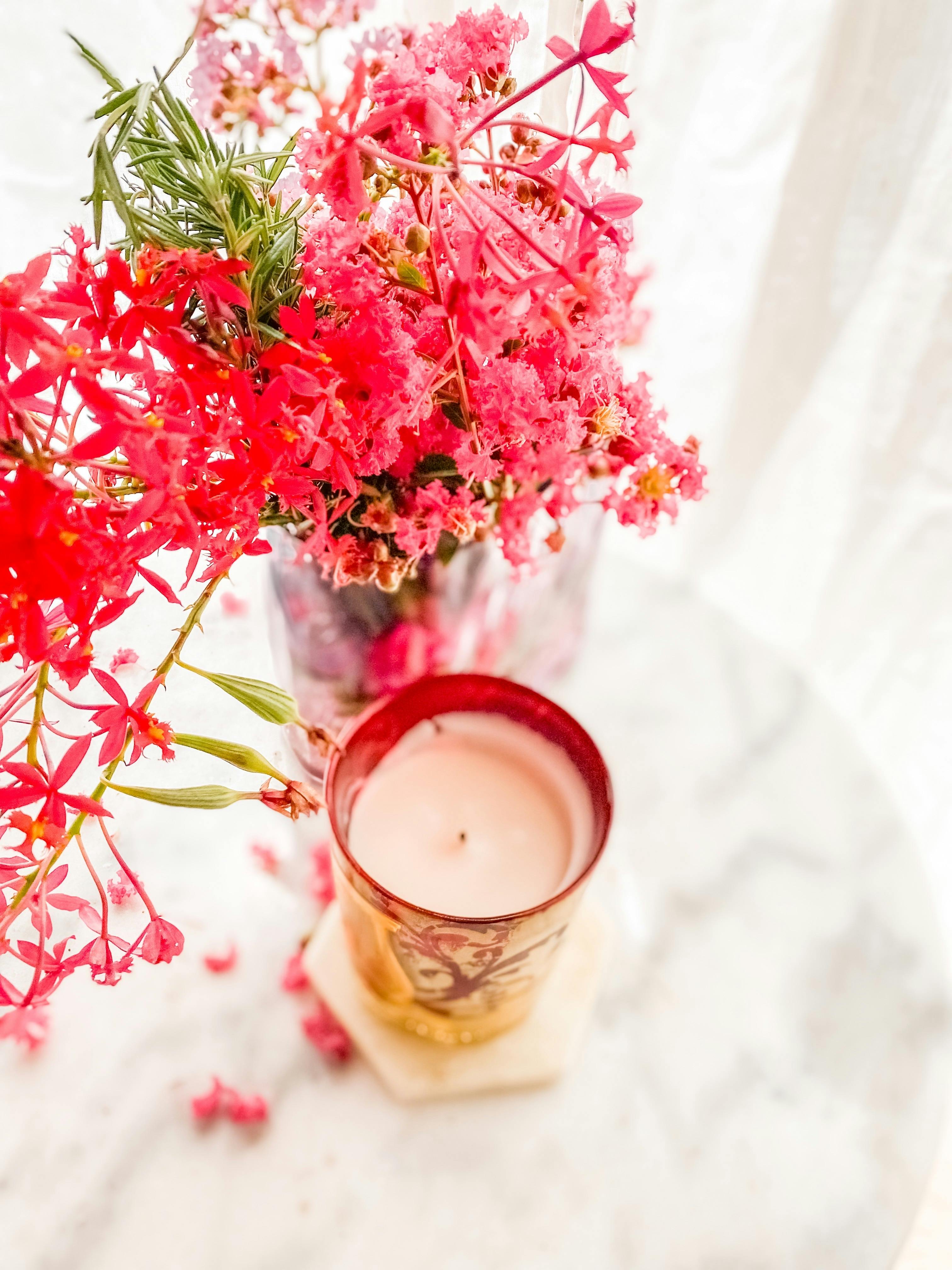 White Flowers Beside a Lighted Candle · Free Stock Photo