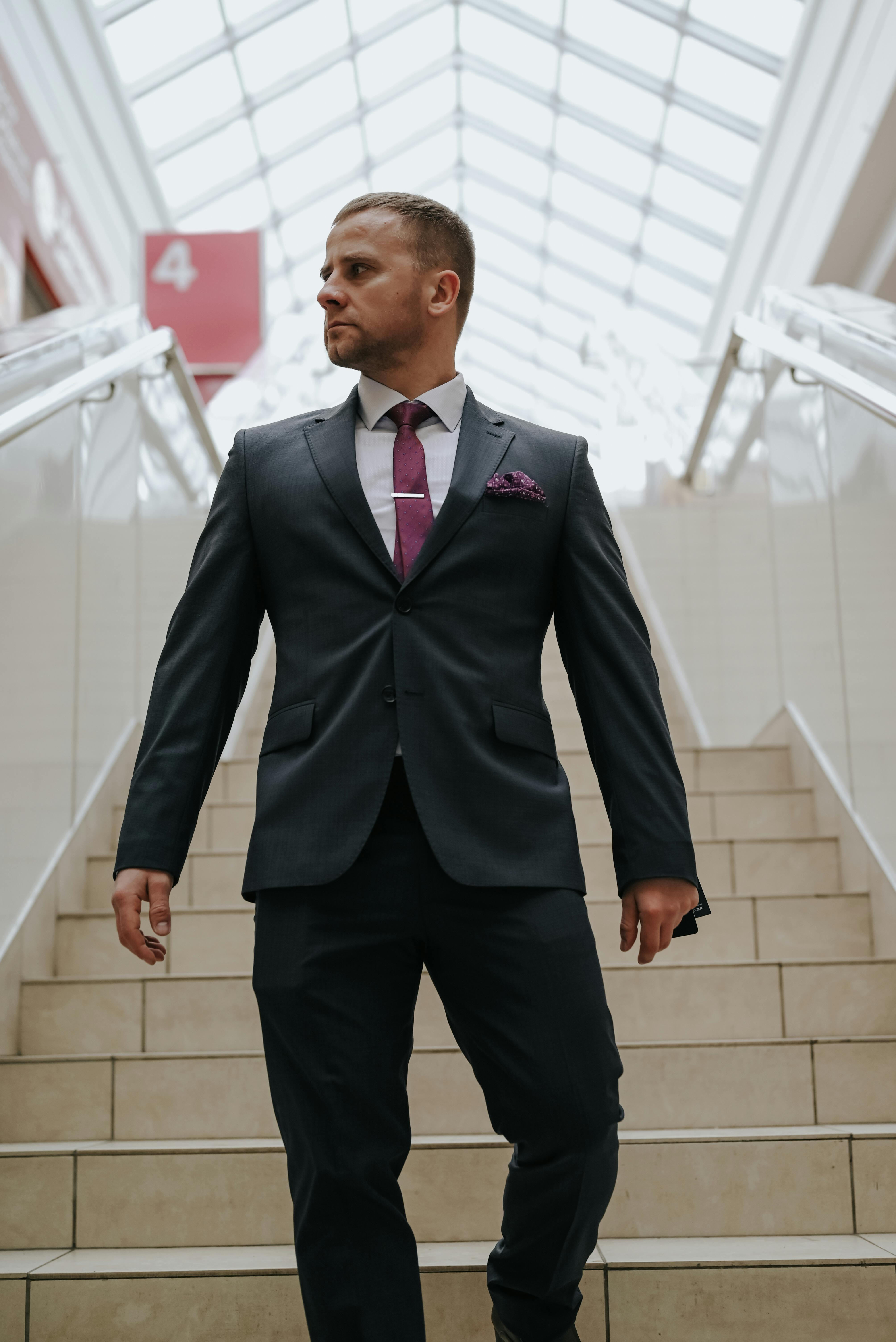 Man in Slim Fit Suit Sitting on Steps · Free Stock Photo