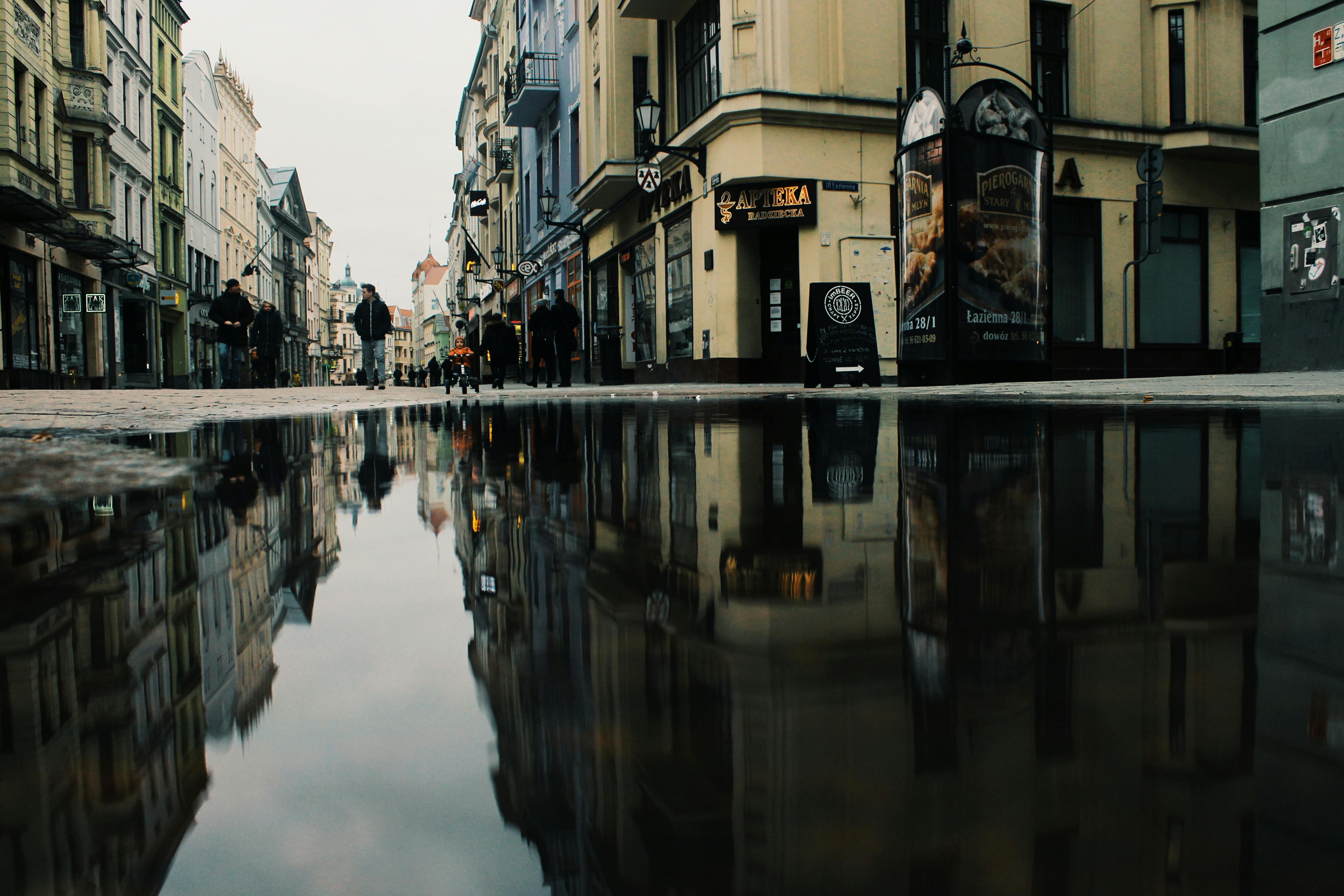 Reflection Of Buildings On Puddle · Free Stock Photo