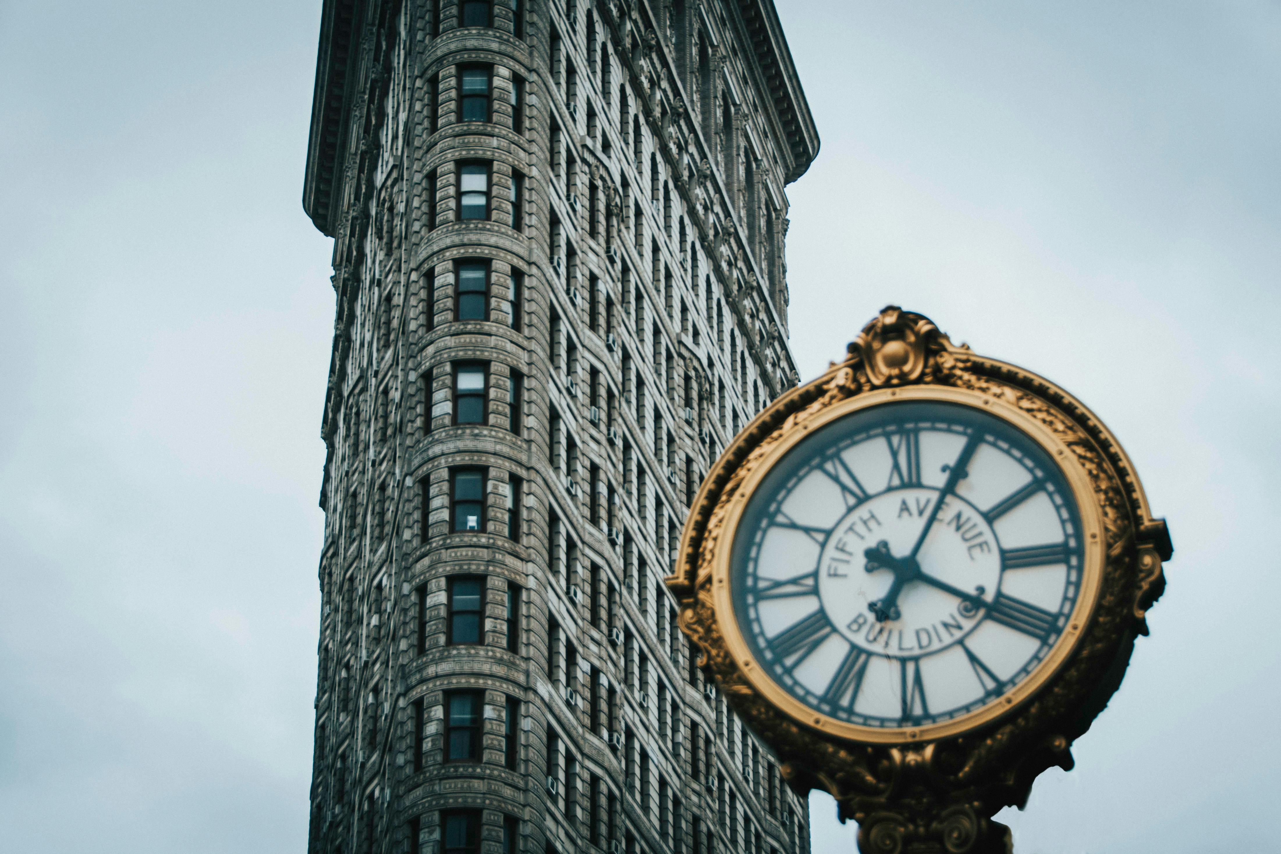 Photo of a Clock in front of a Building · Free Stock Photo