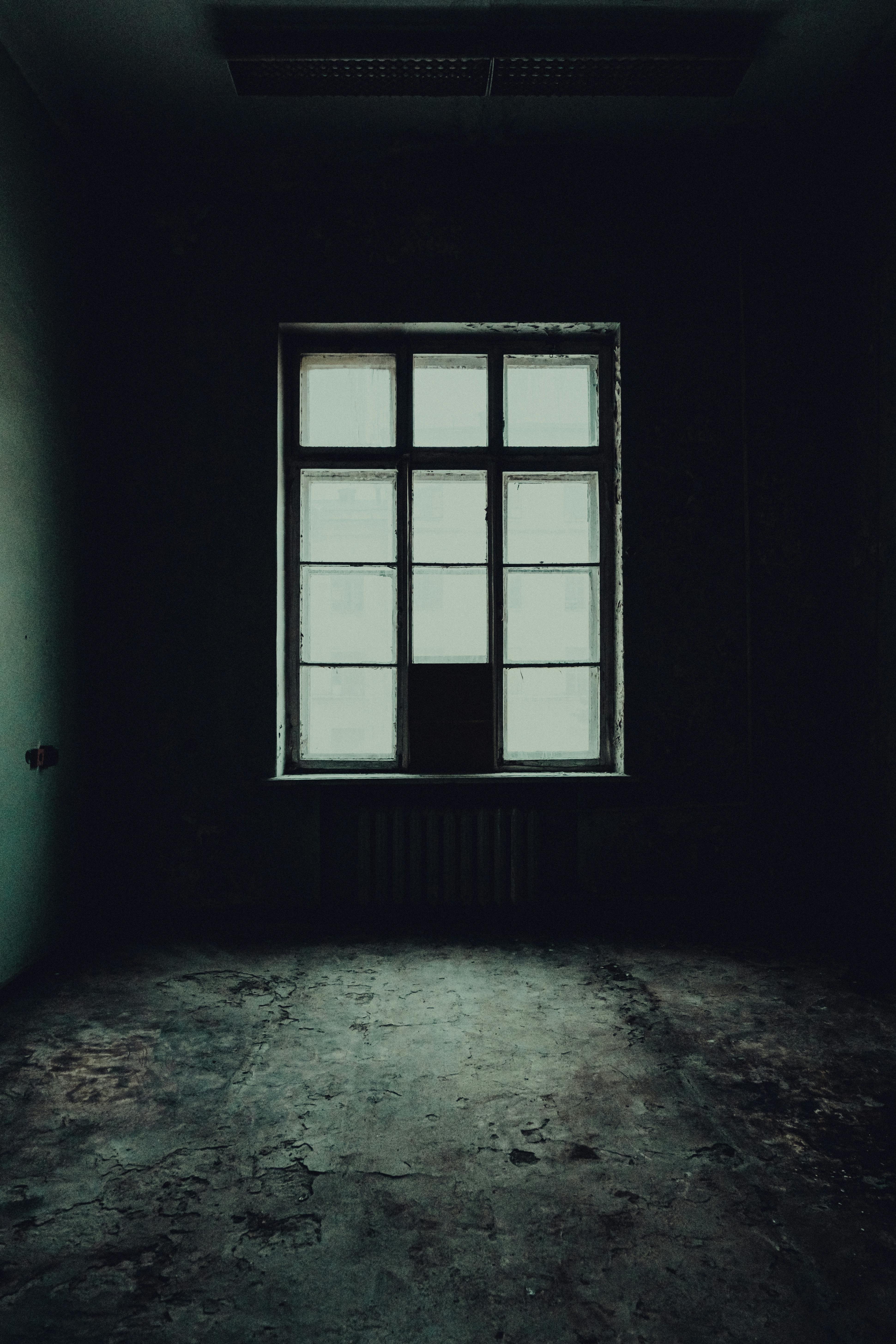 An Empty Dark Room with a Curtain Hanging Loose on Window · Free Stock ...