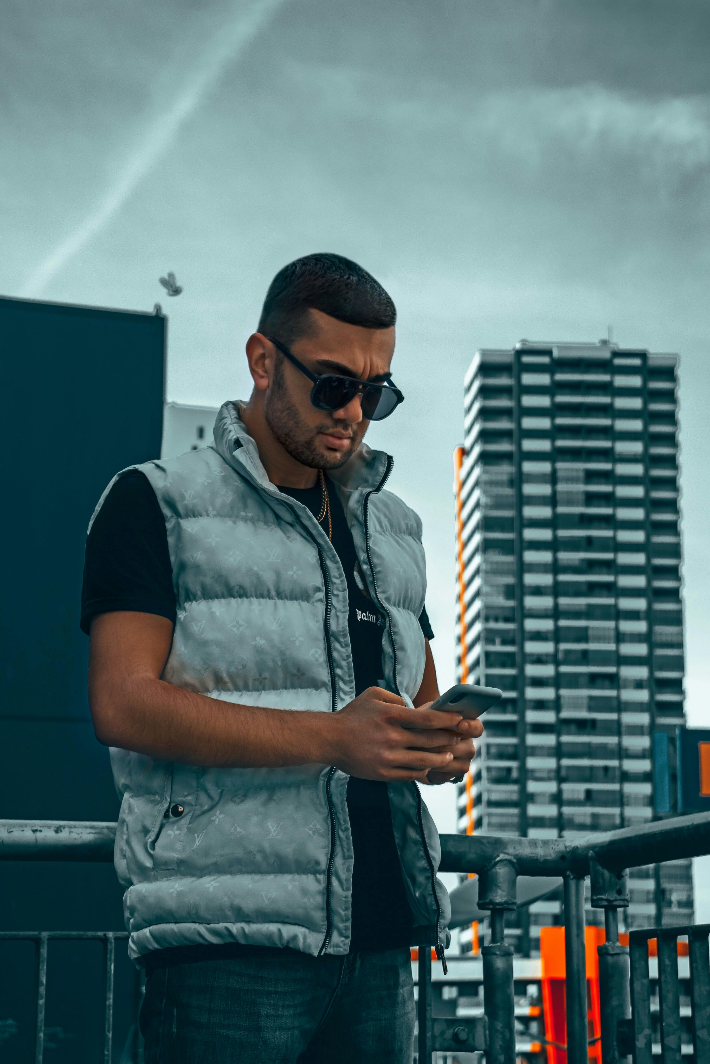 Man Using His Cellphone · Free Stock Photo