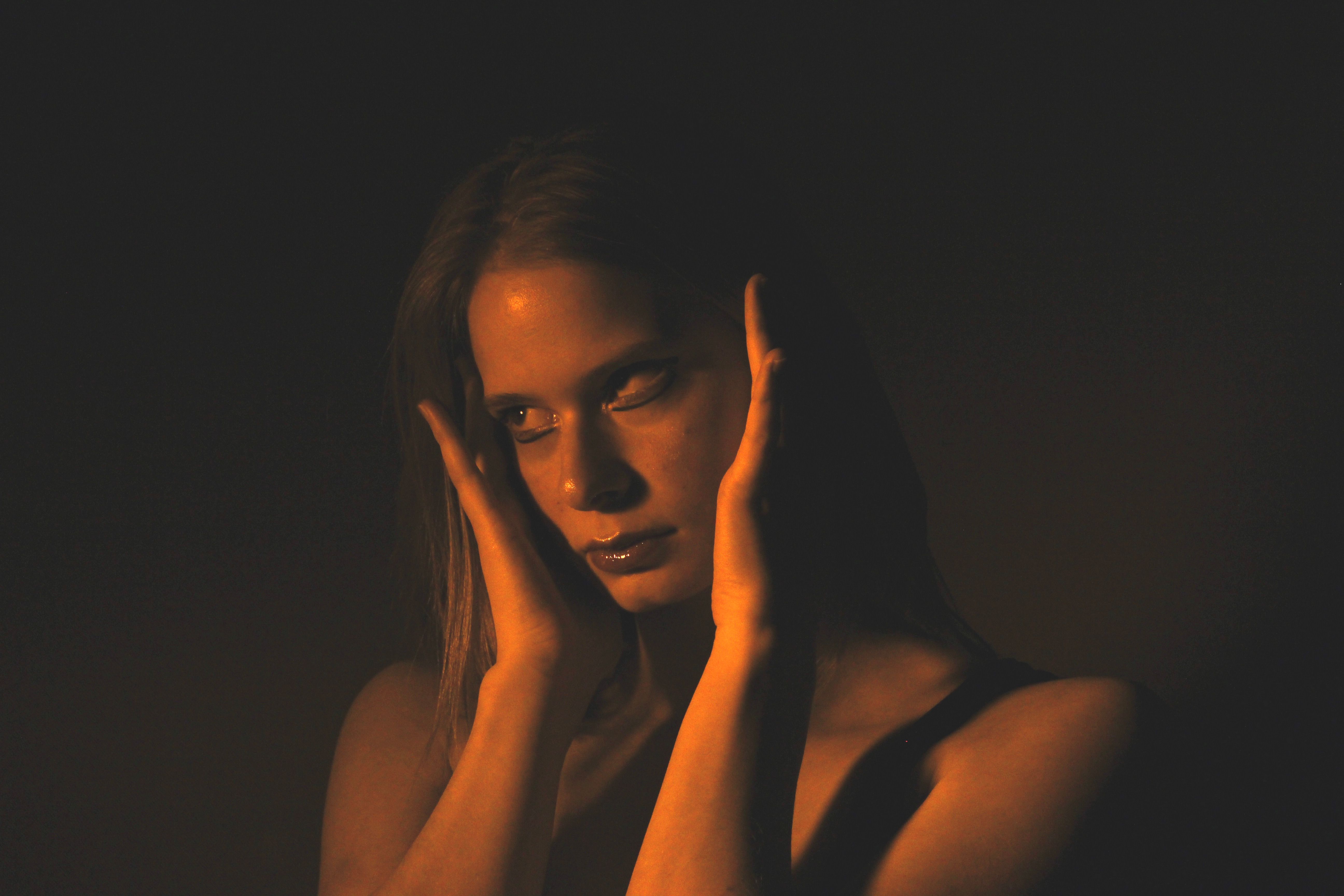 A Creepy Woman Touching Her Head while Looking Afar · Free Stock Photo