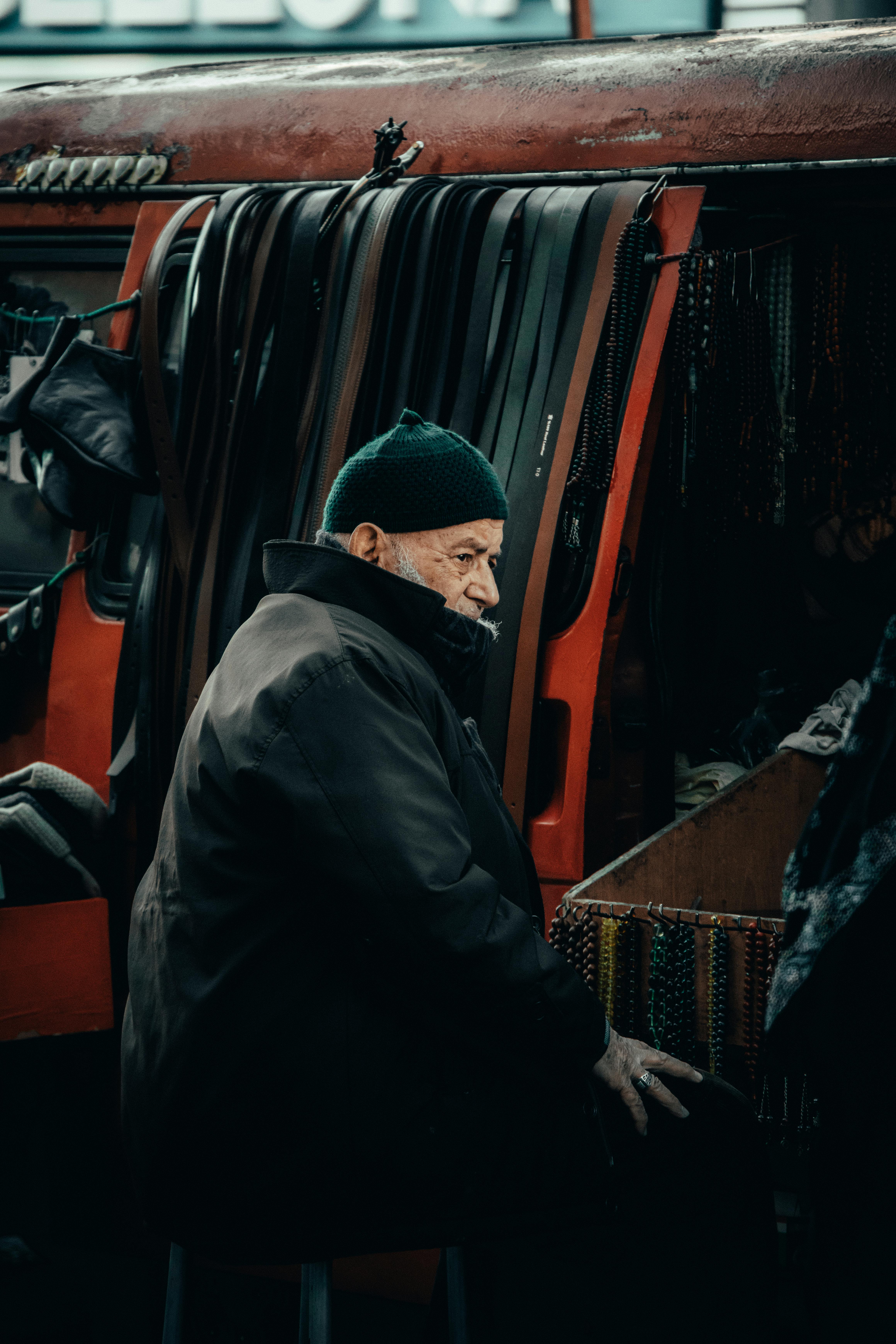 Barefoot Elderly Man Carrying Metal Tanks · Free Stock Photo