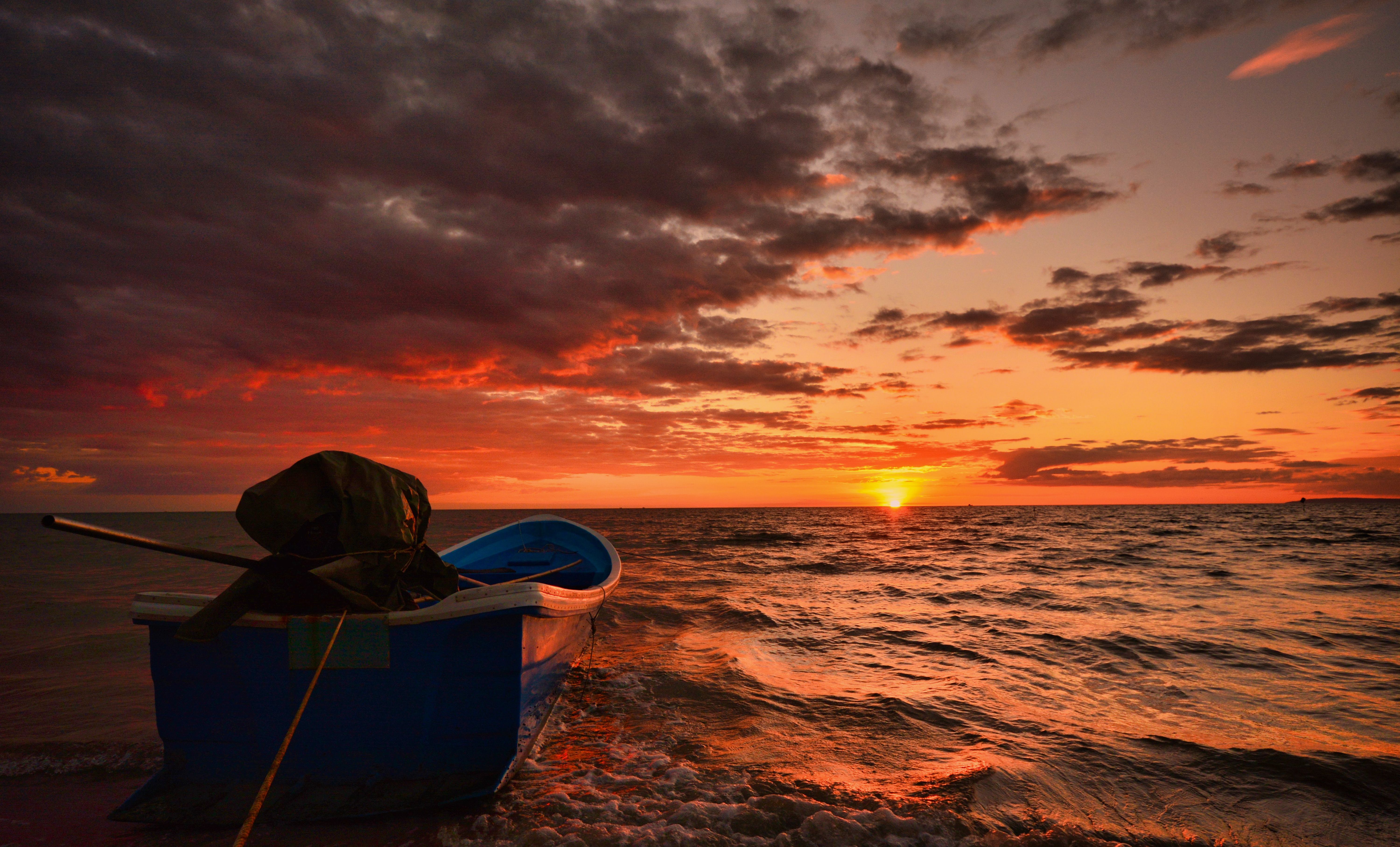 Blue Boat on Sea during Sunset · Free Stock Photo
