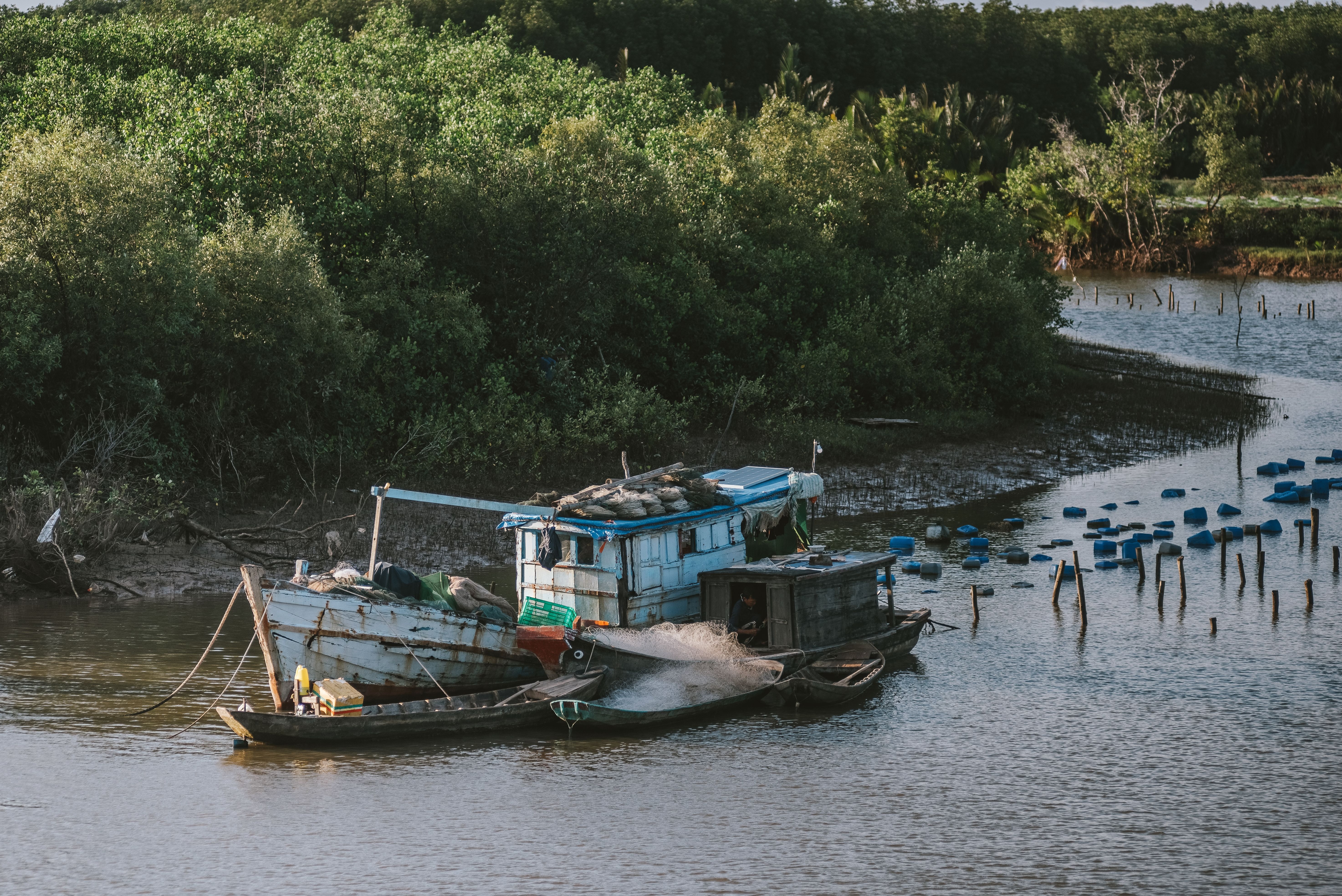 Docked Wooden Fishing Boats near Trees · Free Stock Photo