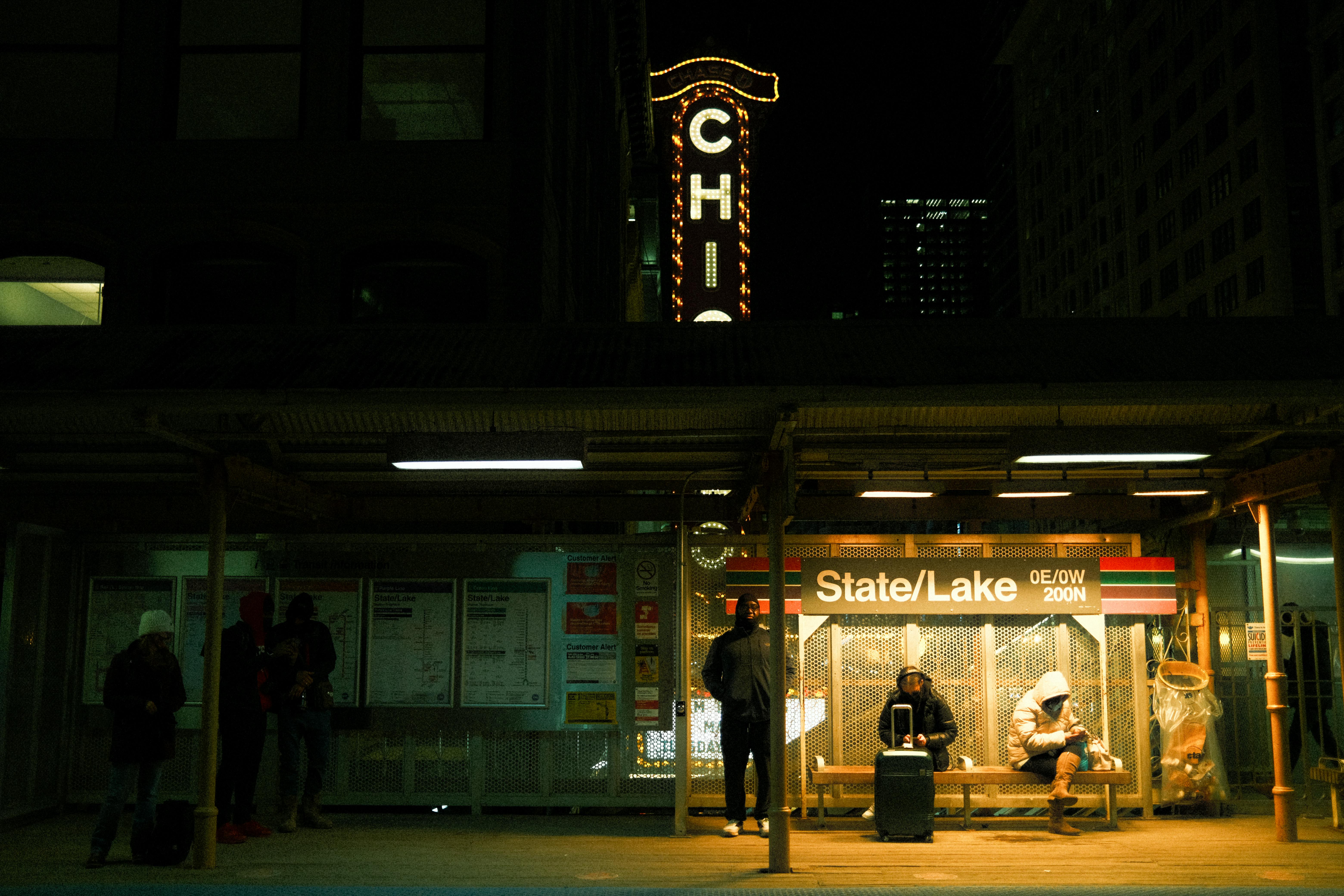 People Waiting on an Illuminated Strain Station at Night · Free Stock Photo