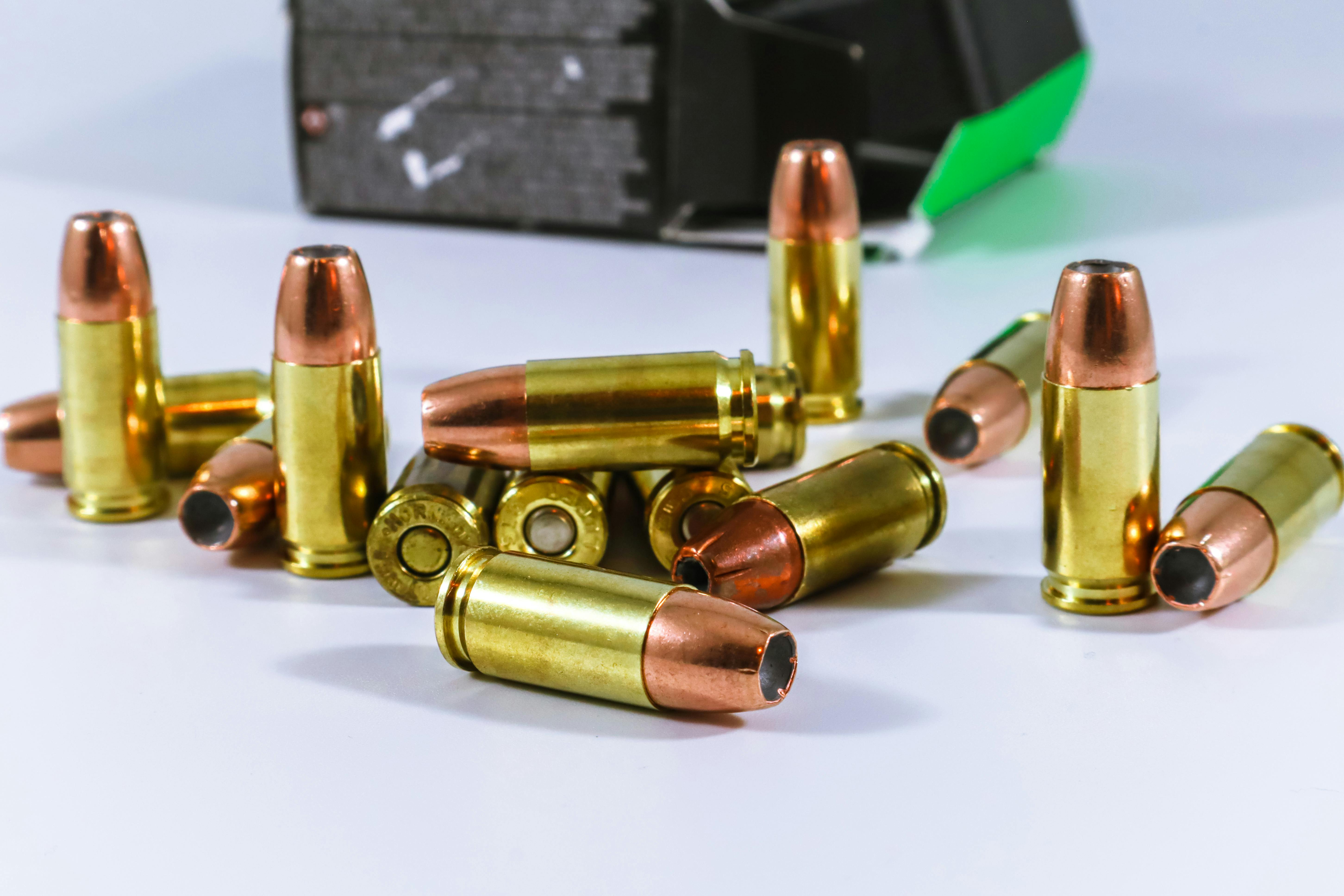 Bullet Collection on White Surface · Free Stock Photo