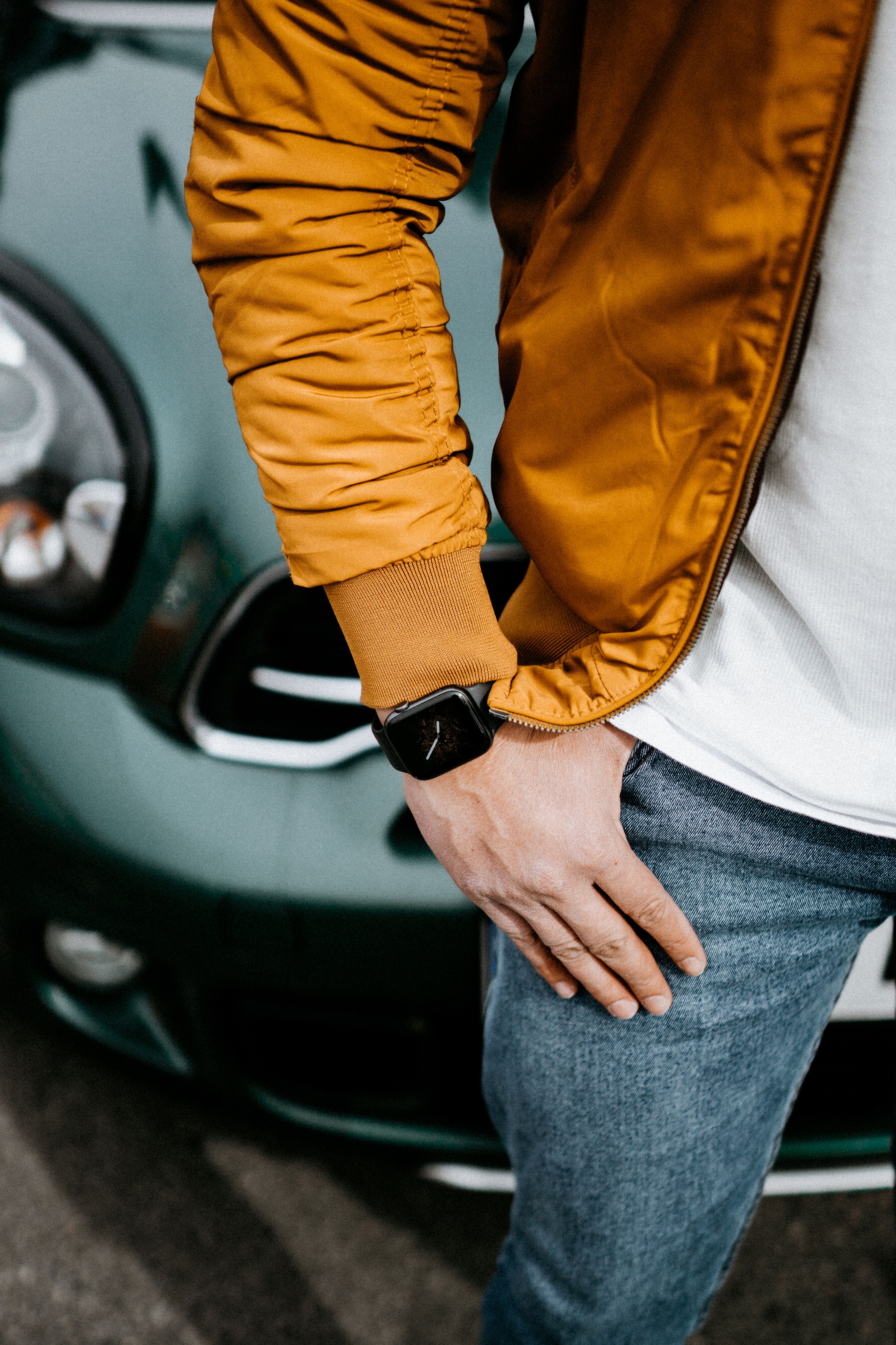 A Person in Jacket Wearing Smartwatch while Leaning on a Car · Free ...