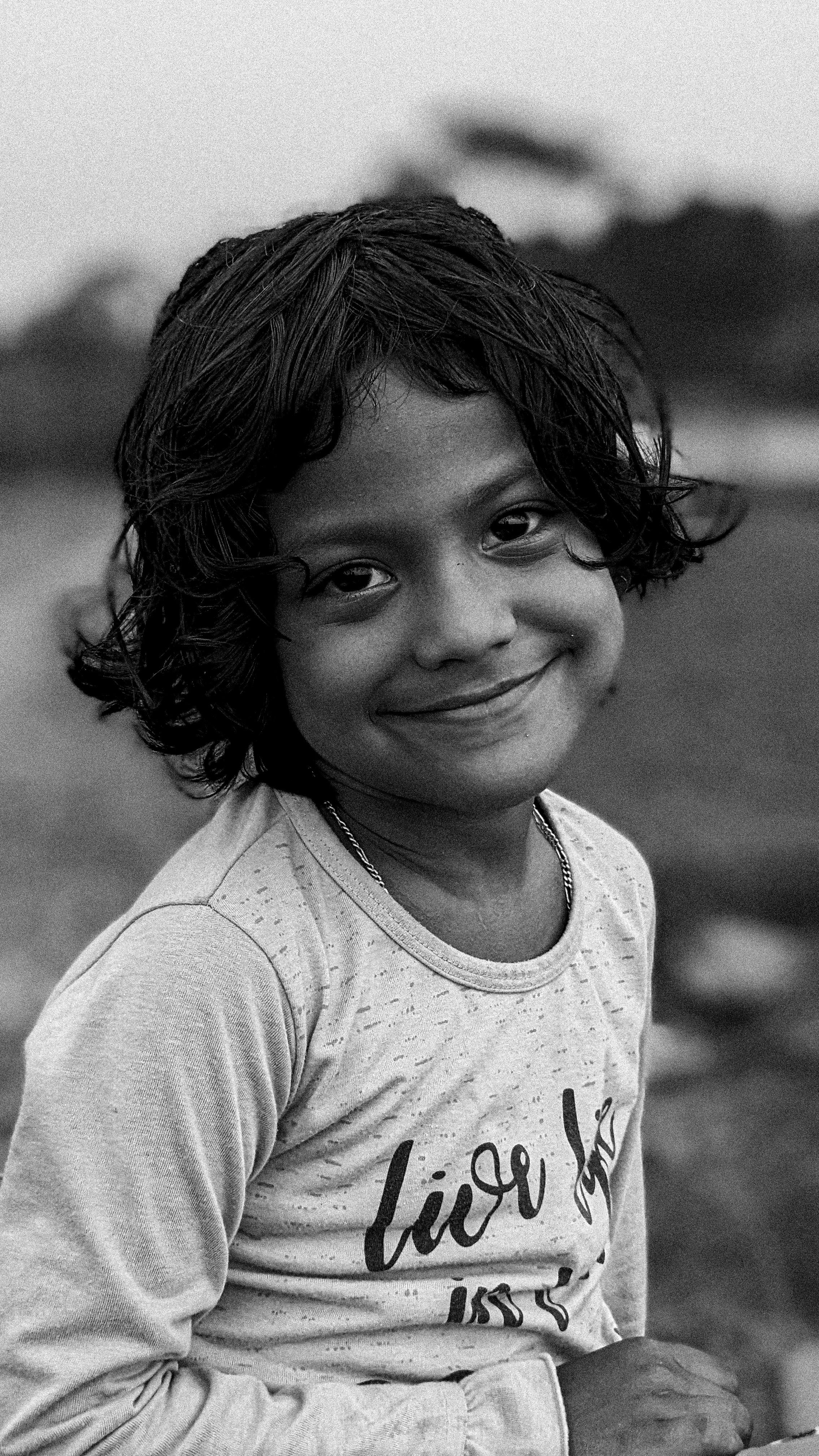 Grayscale Photo of a Child Smiling · Free Stock Photo