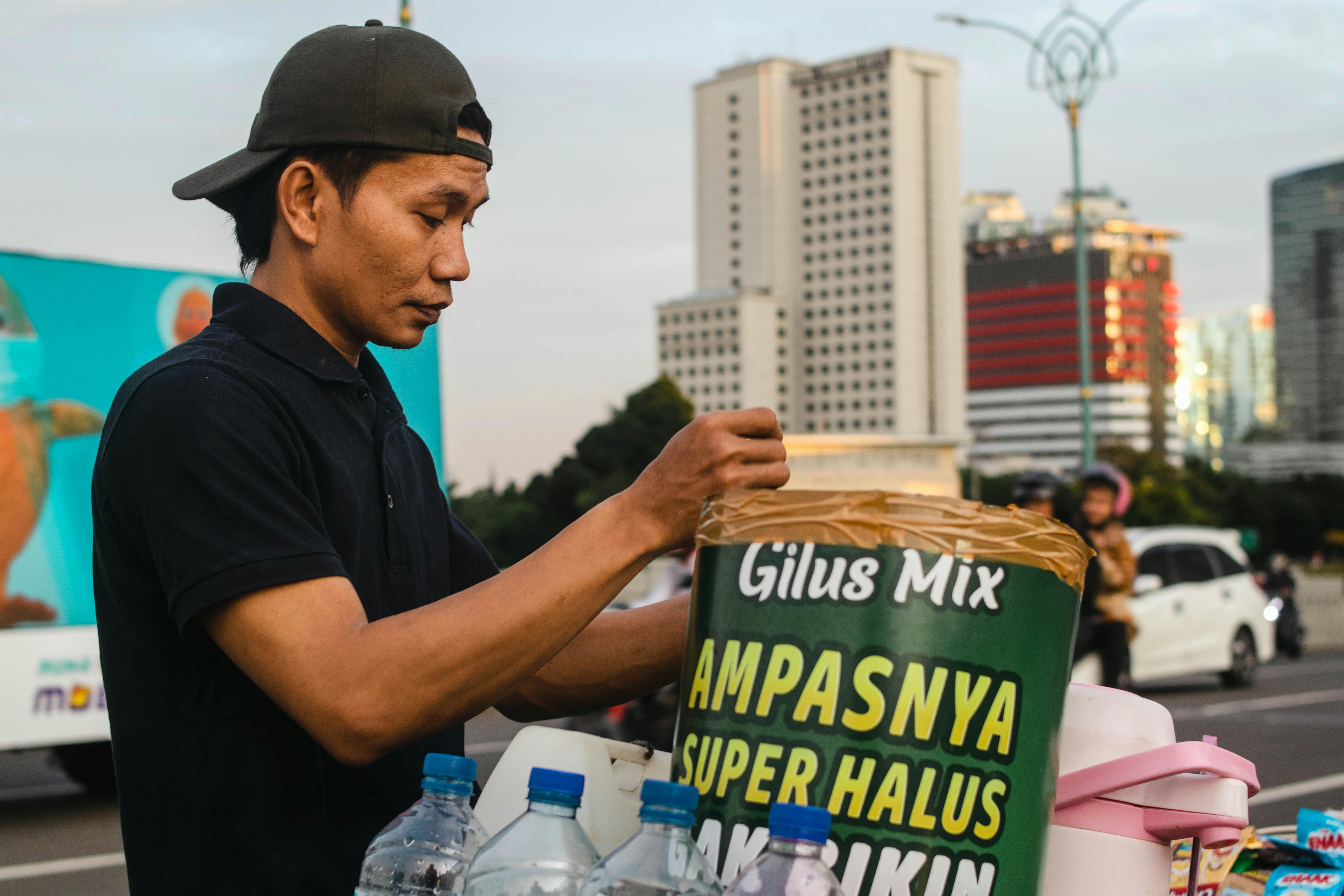 A Street Vendor Mixing Lemonade at his Stall · Free Stock Photo