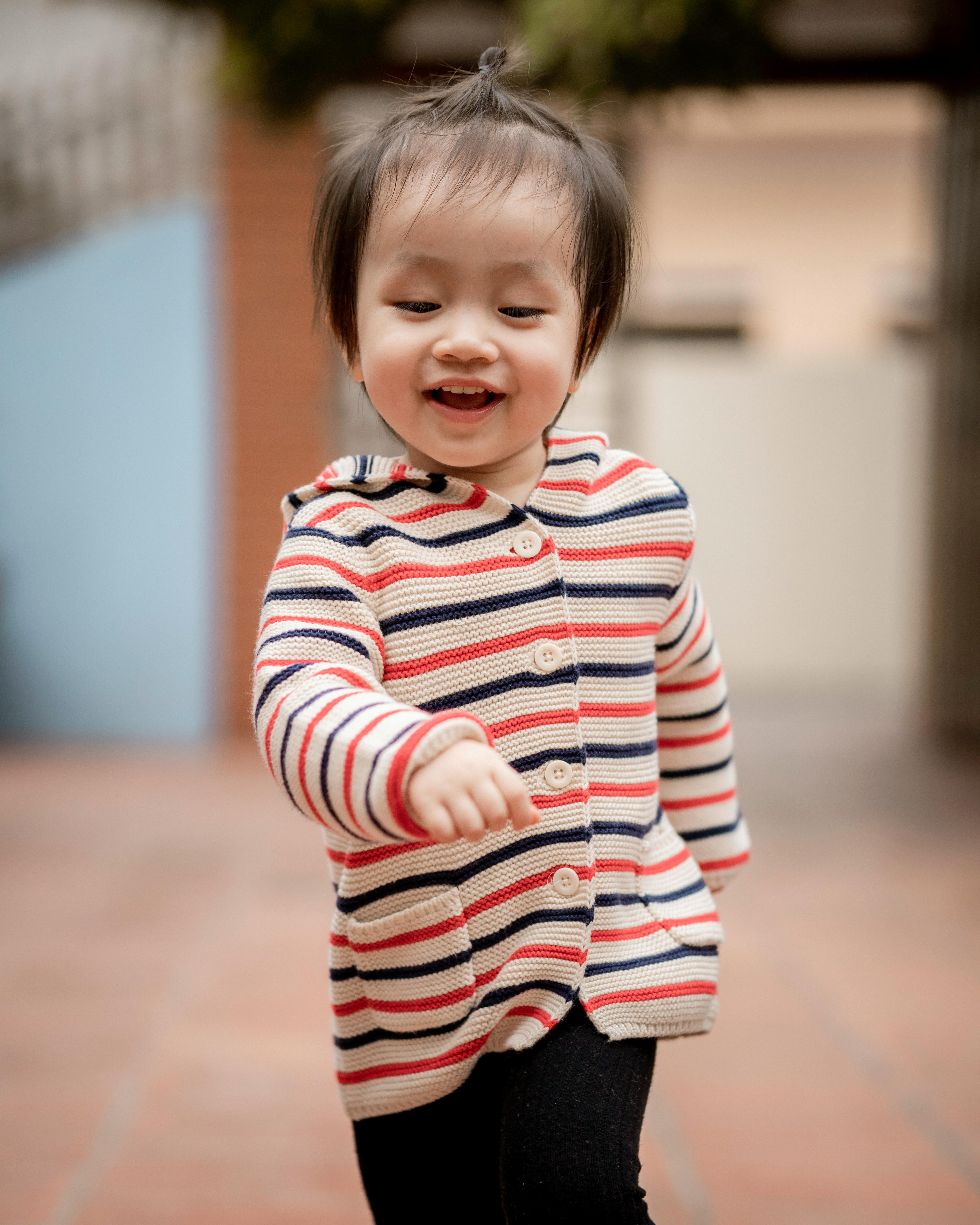 Close-Up Photo of a Cute Girl Smiling while Hugging Her Stuffed Toy ...
