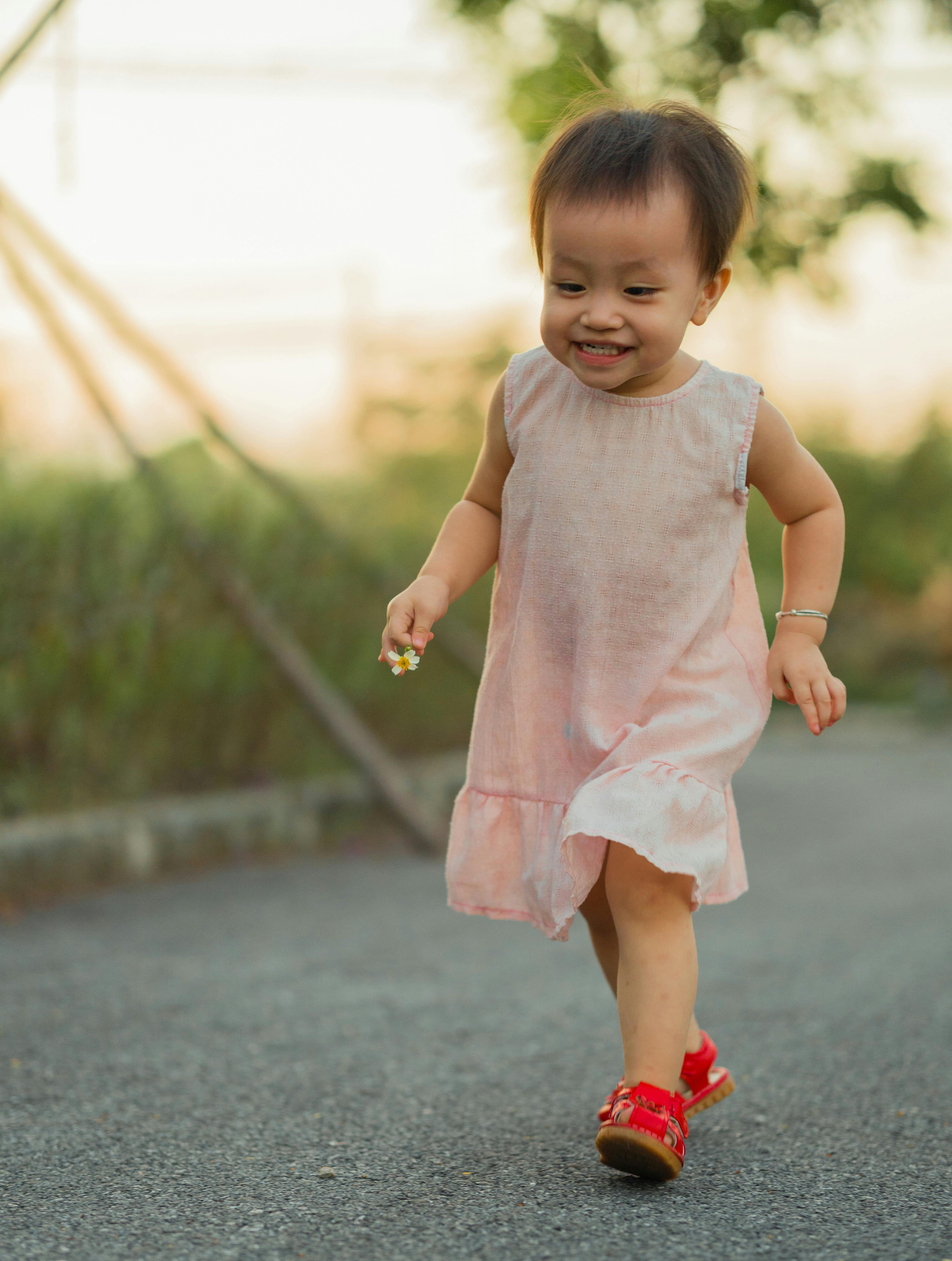 Photo of a Kid in a Pink Dress Running · Free Stock Photo