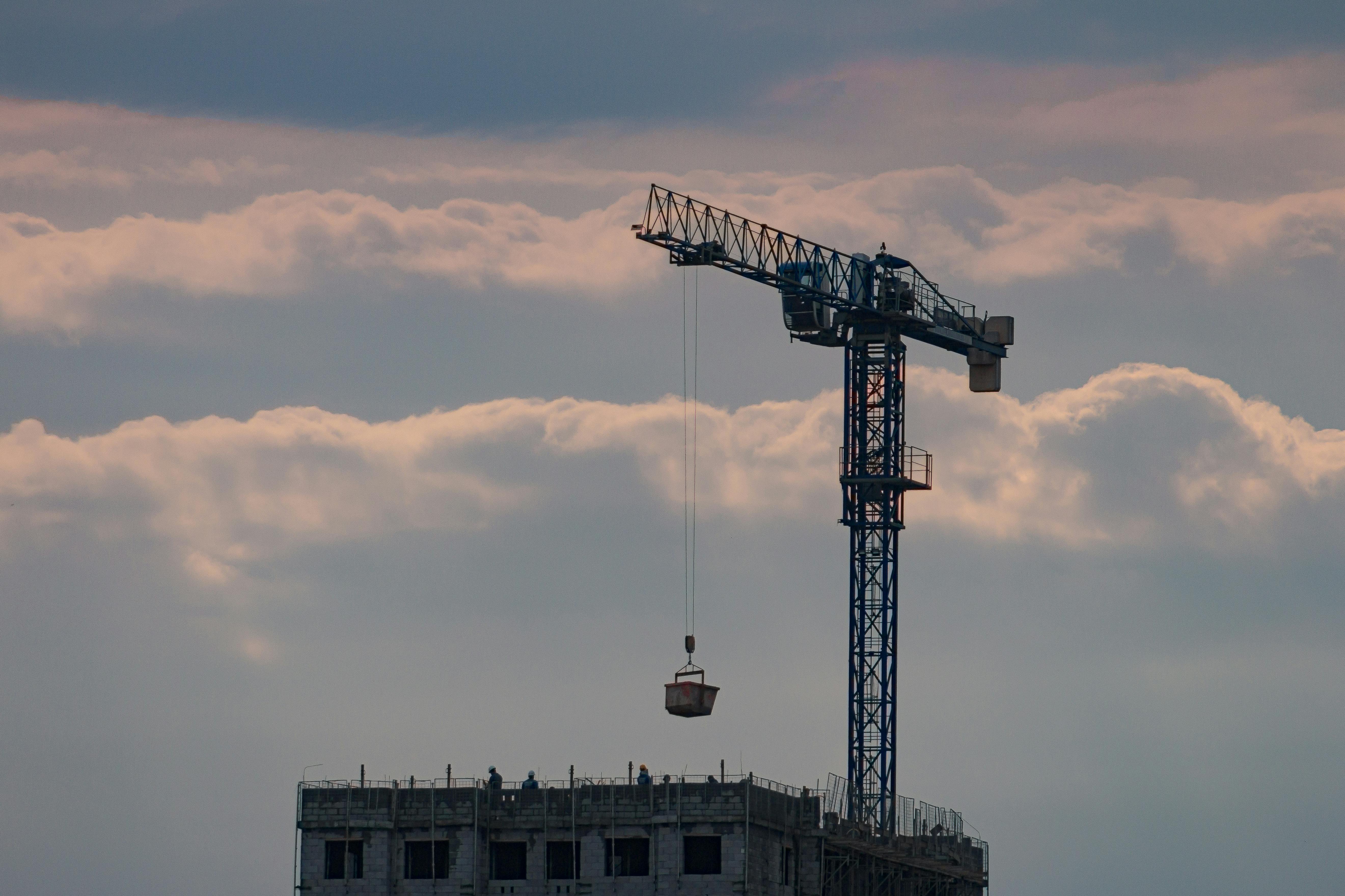 Low Angle Shot of a Crane at a Construction Site · Free Low Angle Shot of a Crane at a Construction Site · Free