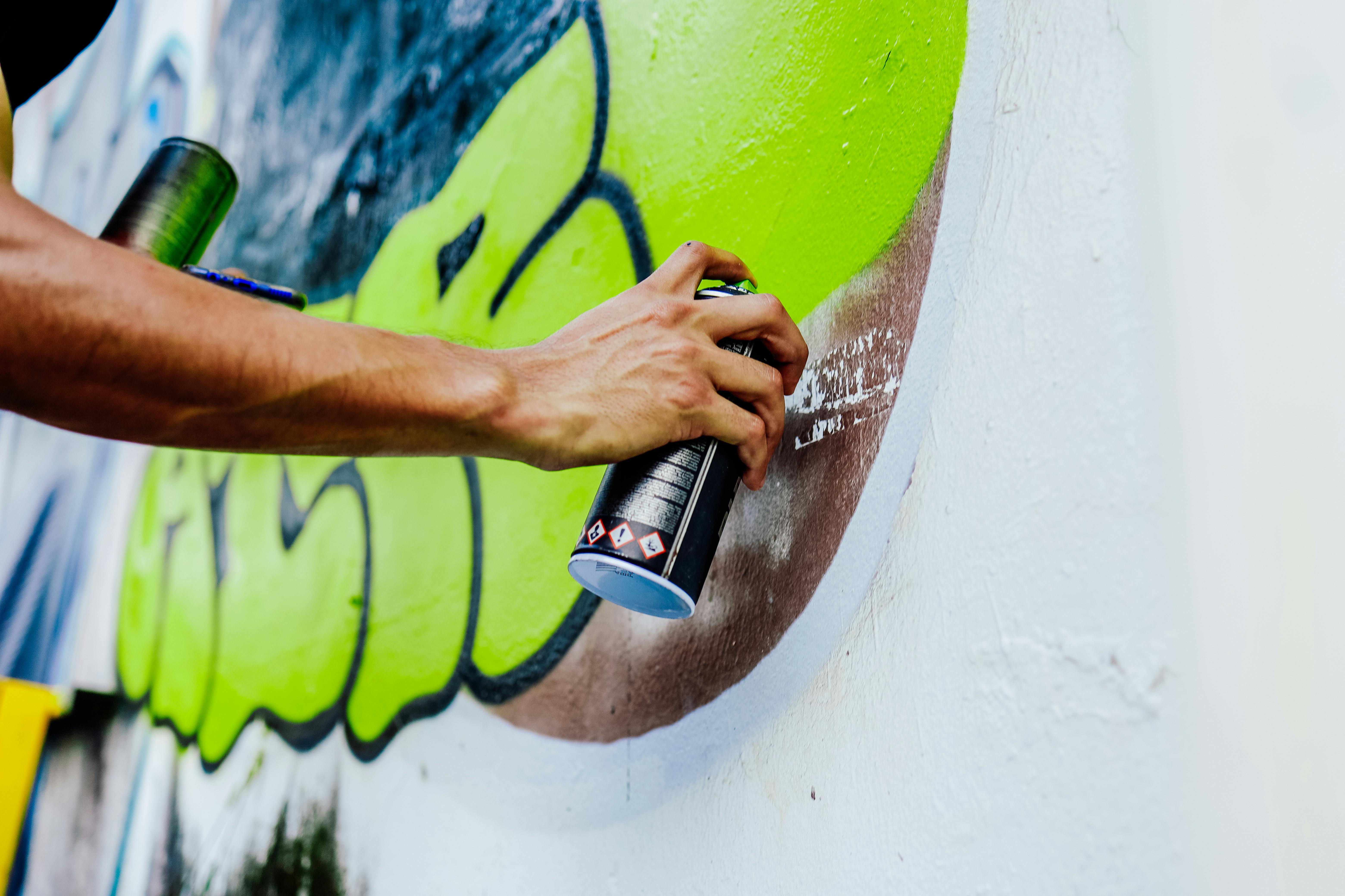 Person Drawing Graffiti on Wall · Free Stock Photo