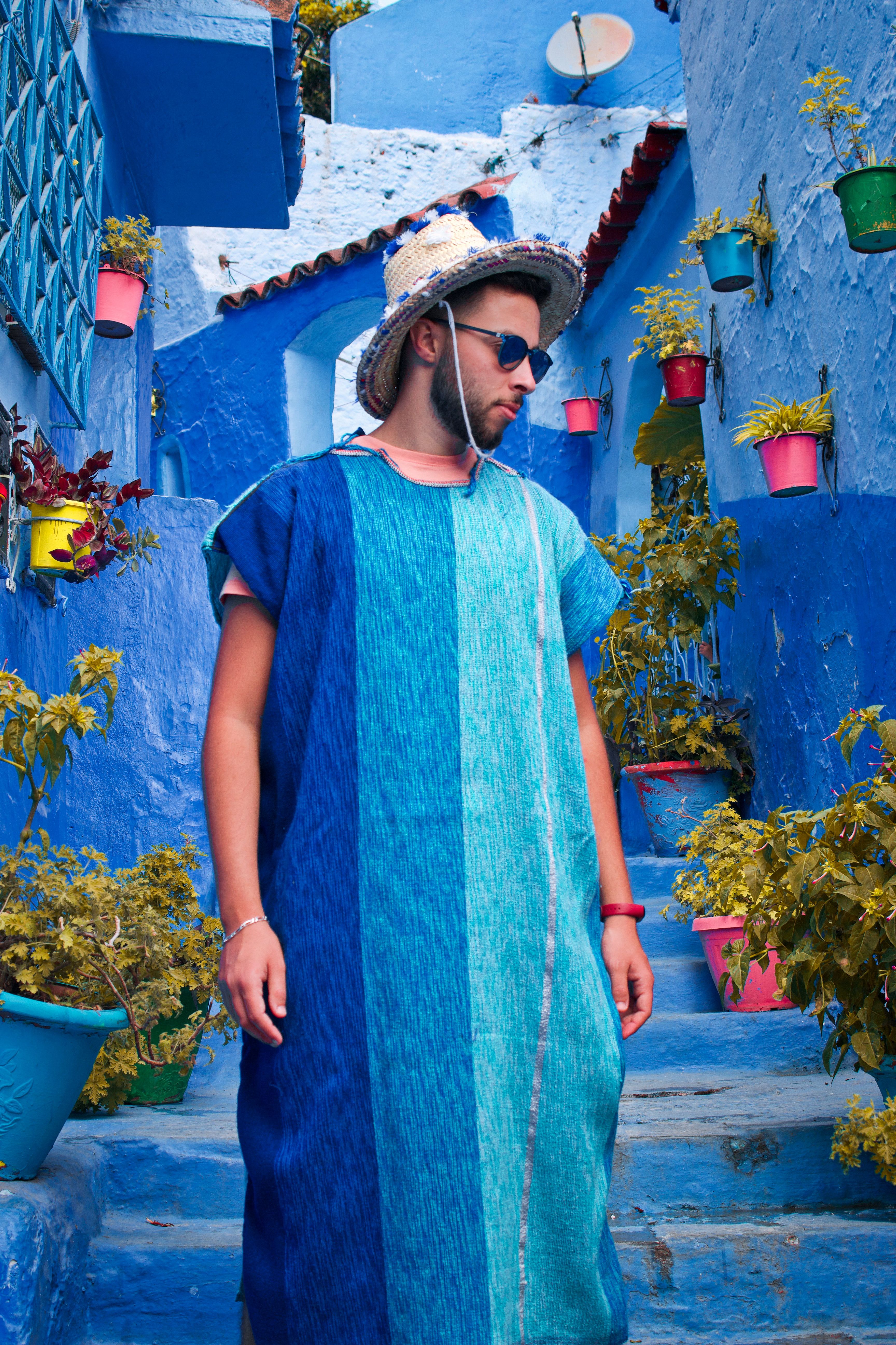 A Man Wearing Blue Djellaba Standing on Clue Painted Steps · Free Stock ...