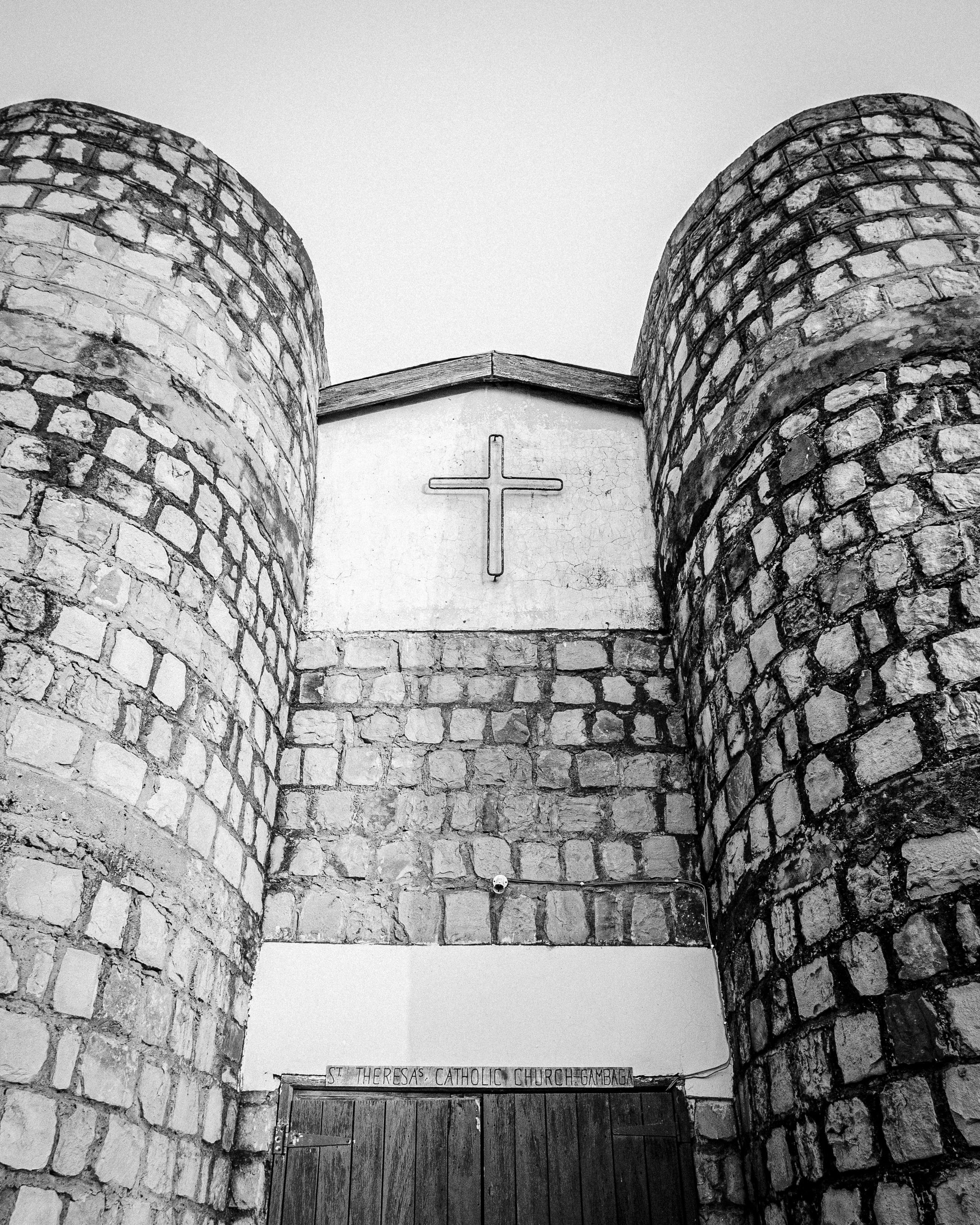 Grayscale Photo of Brick Building with Cross on Wall · Free Stock Photo
