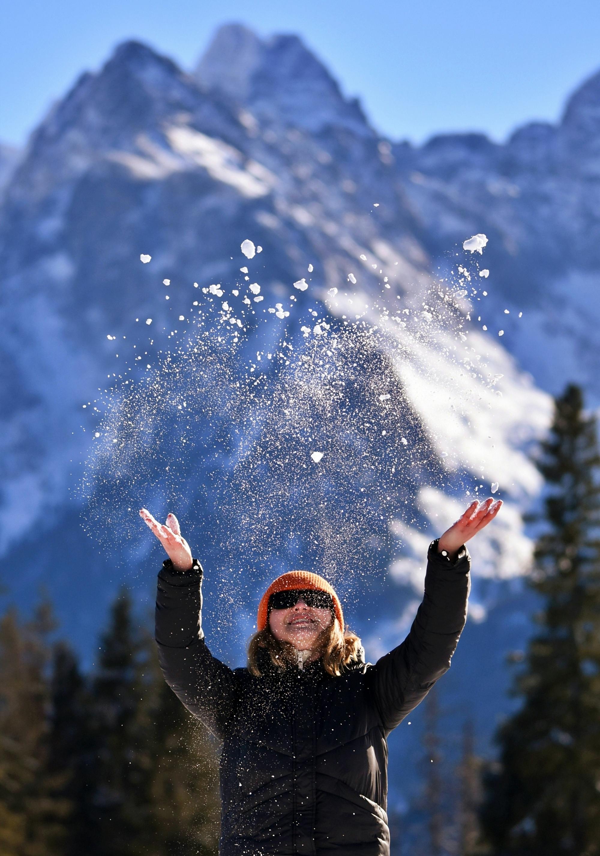 Woman In Black Coat Hit With Snowball On The Head · Free Stock Photo