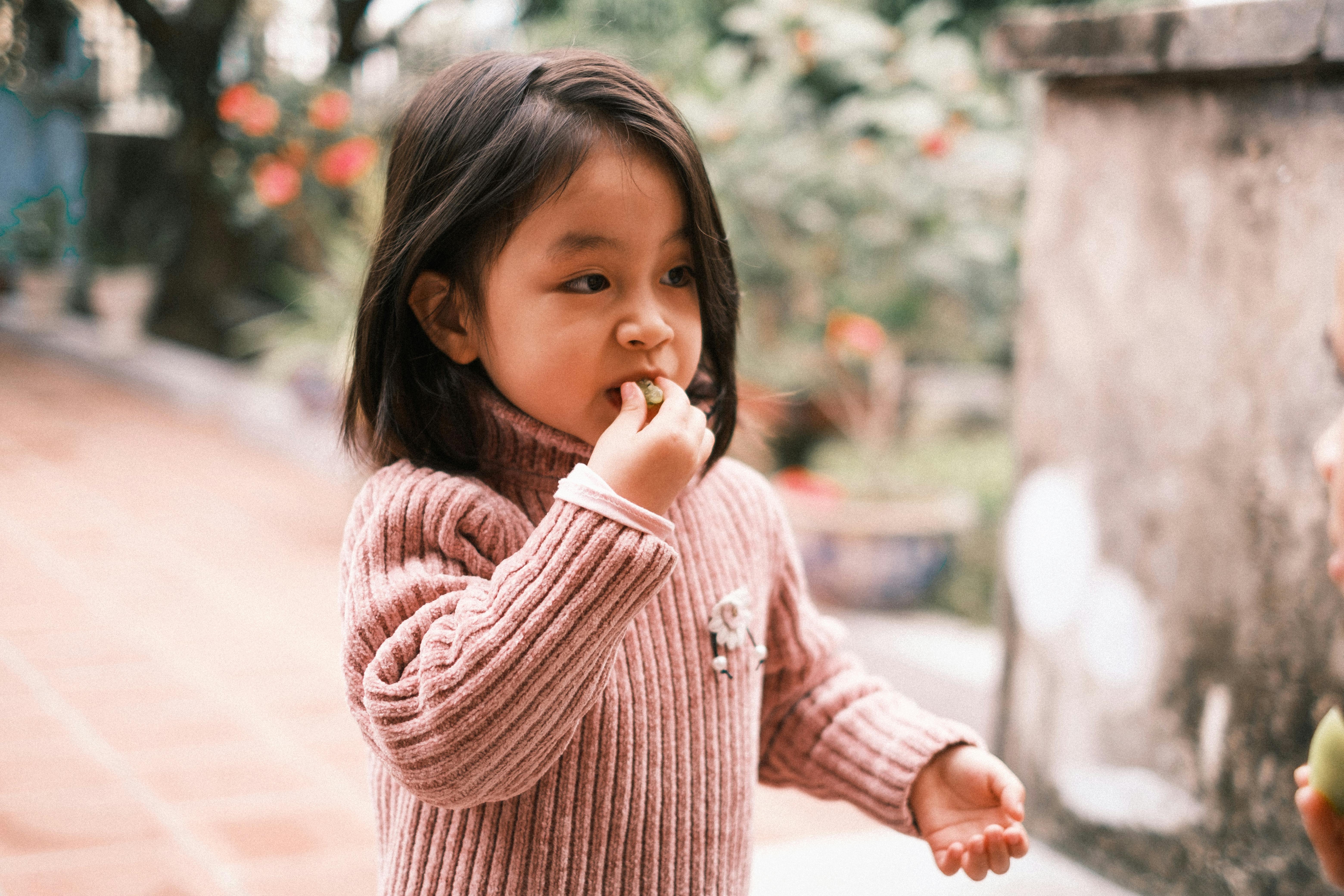 Little Girl Eating a Snack · Free Stock Photo