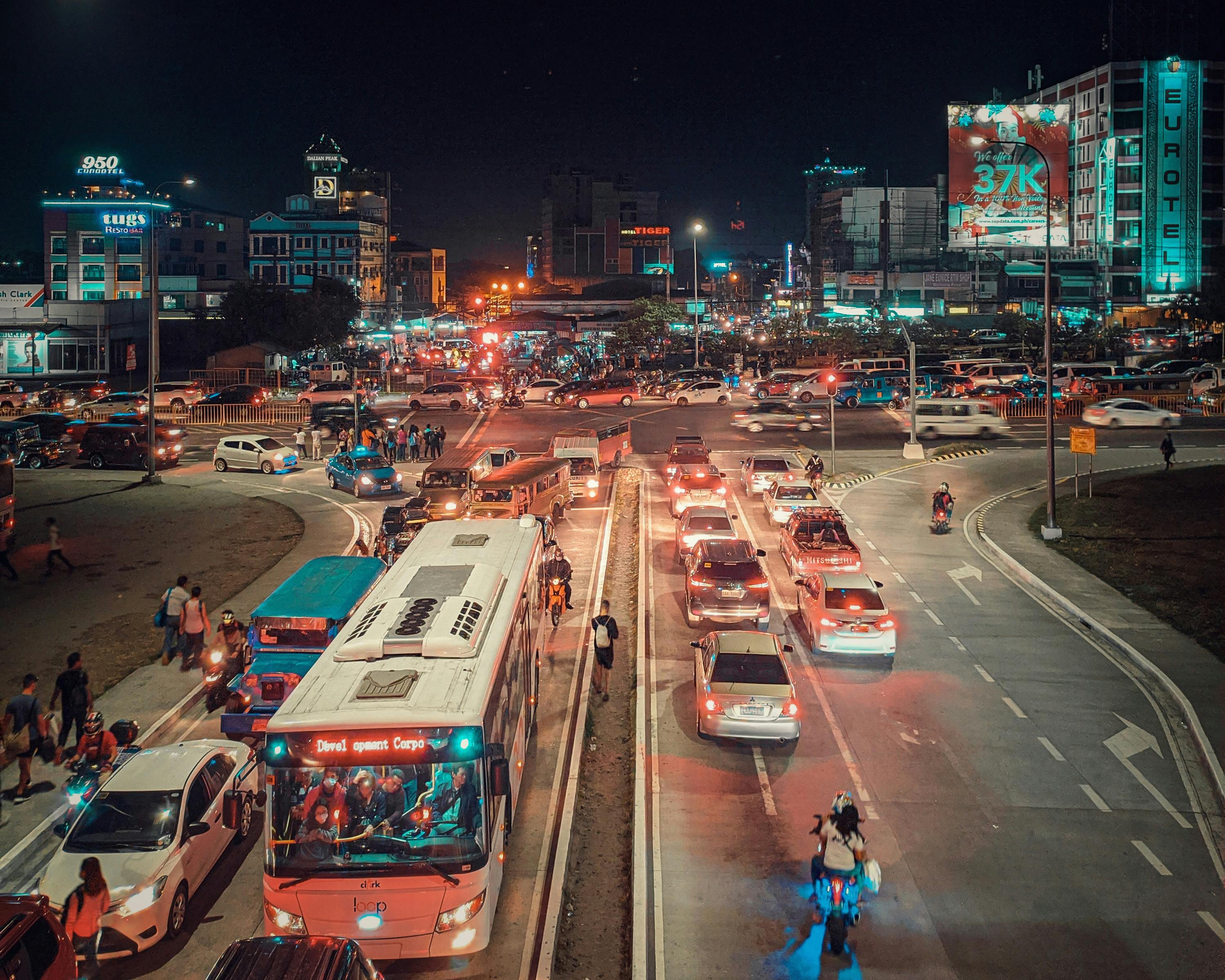 People Walking Near Vehicles on Road During Night Time · Free Stock Photo