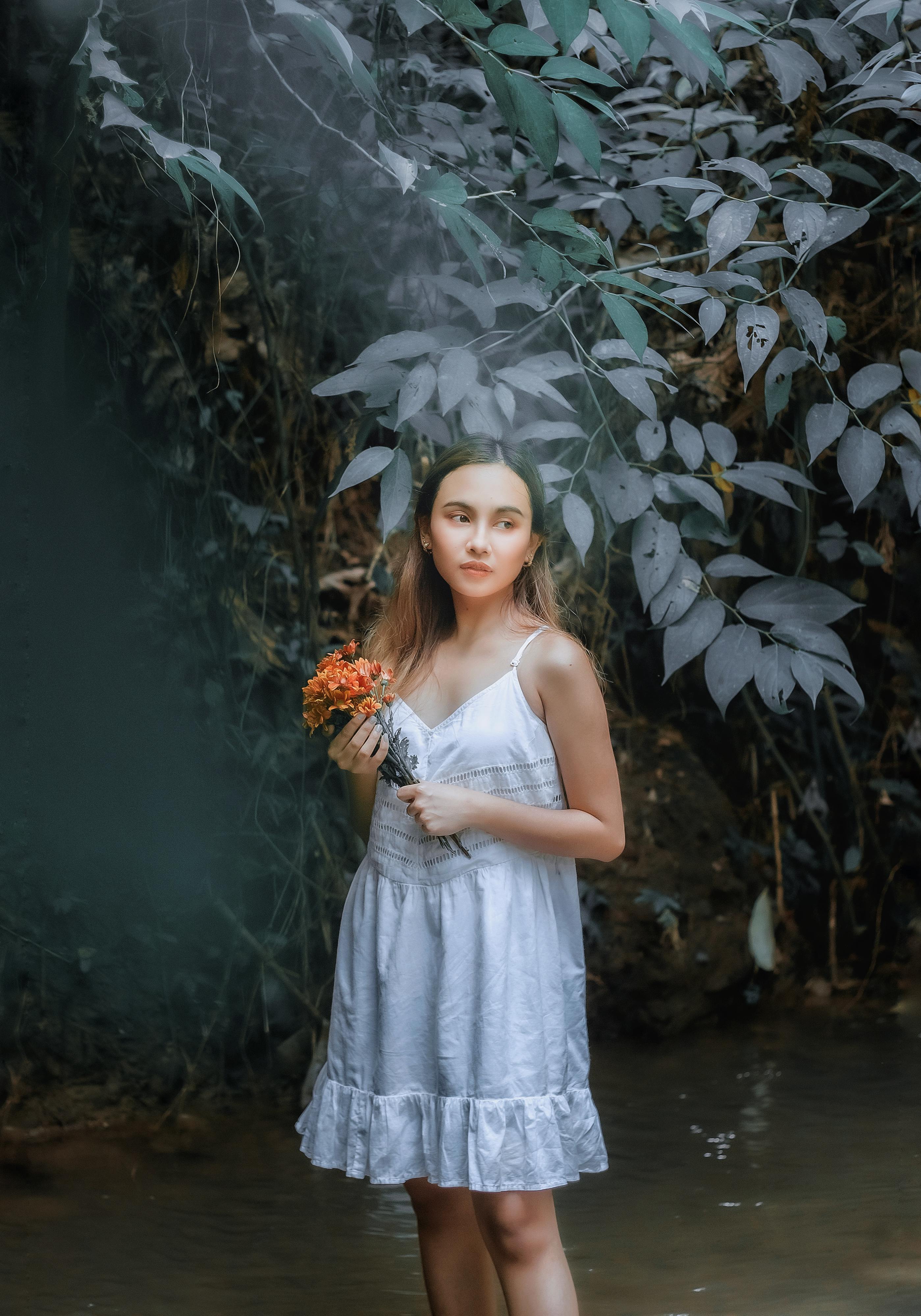 Woman Surrounded by Flowers · Free Stock Photo