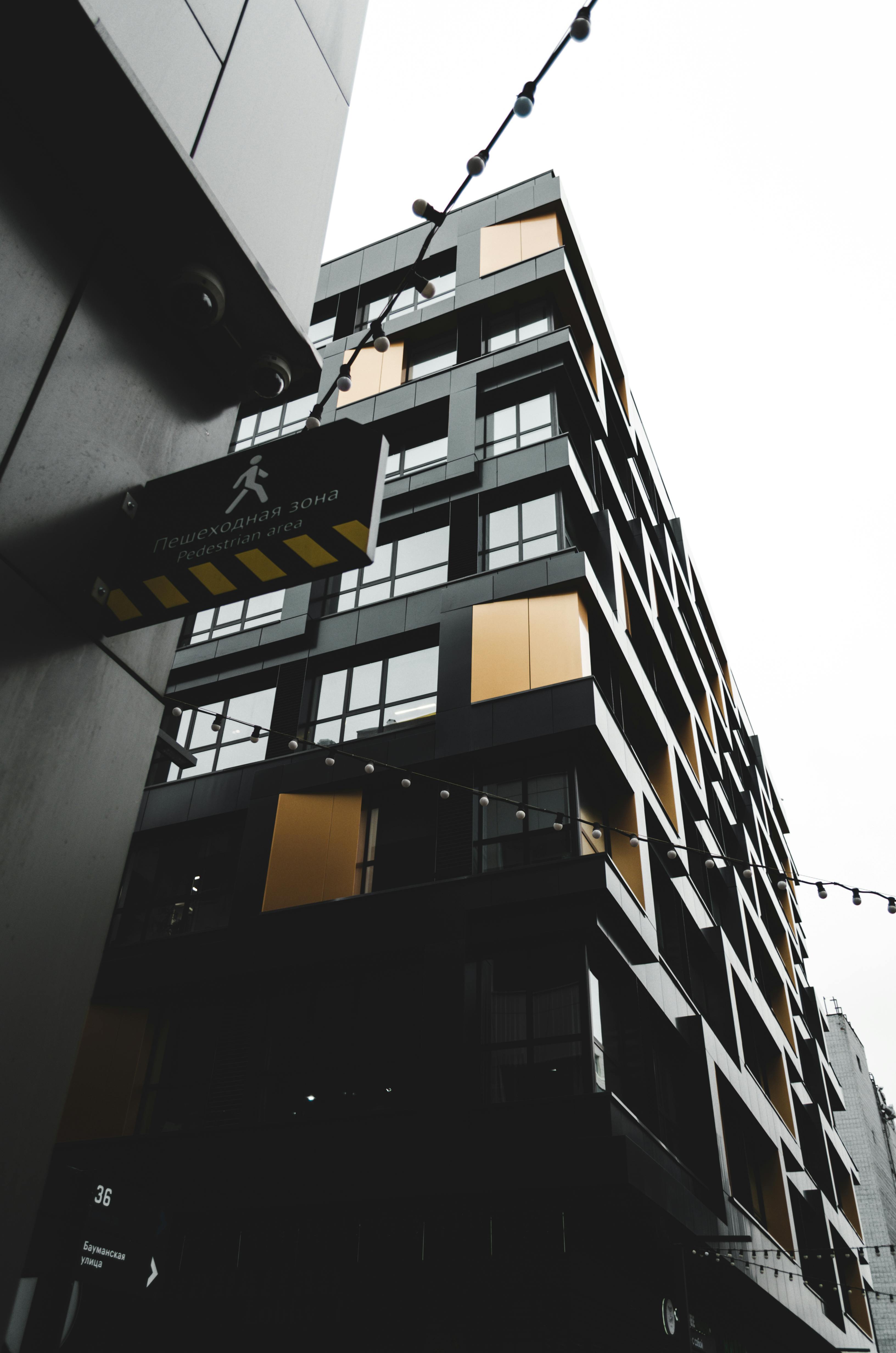Black and Yellow Building Under White Sky · Free Stock Photo