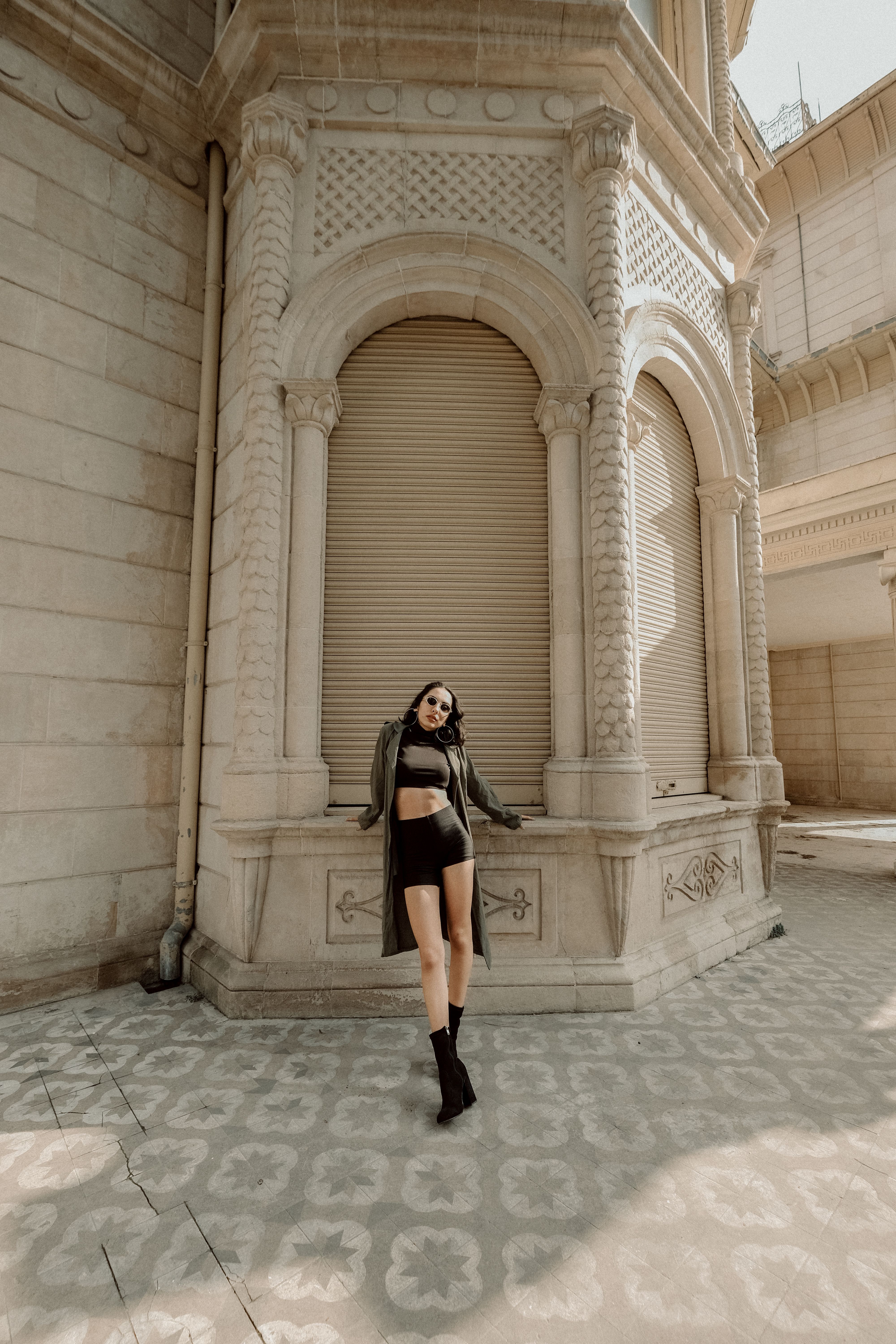 A Woman Posing in Front of an Arched Window · Free Stock Photo