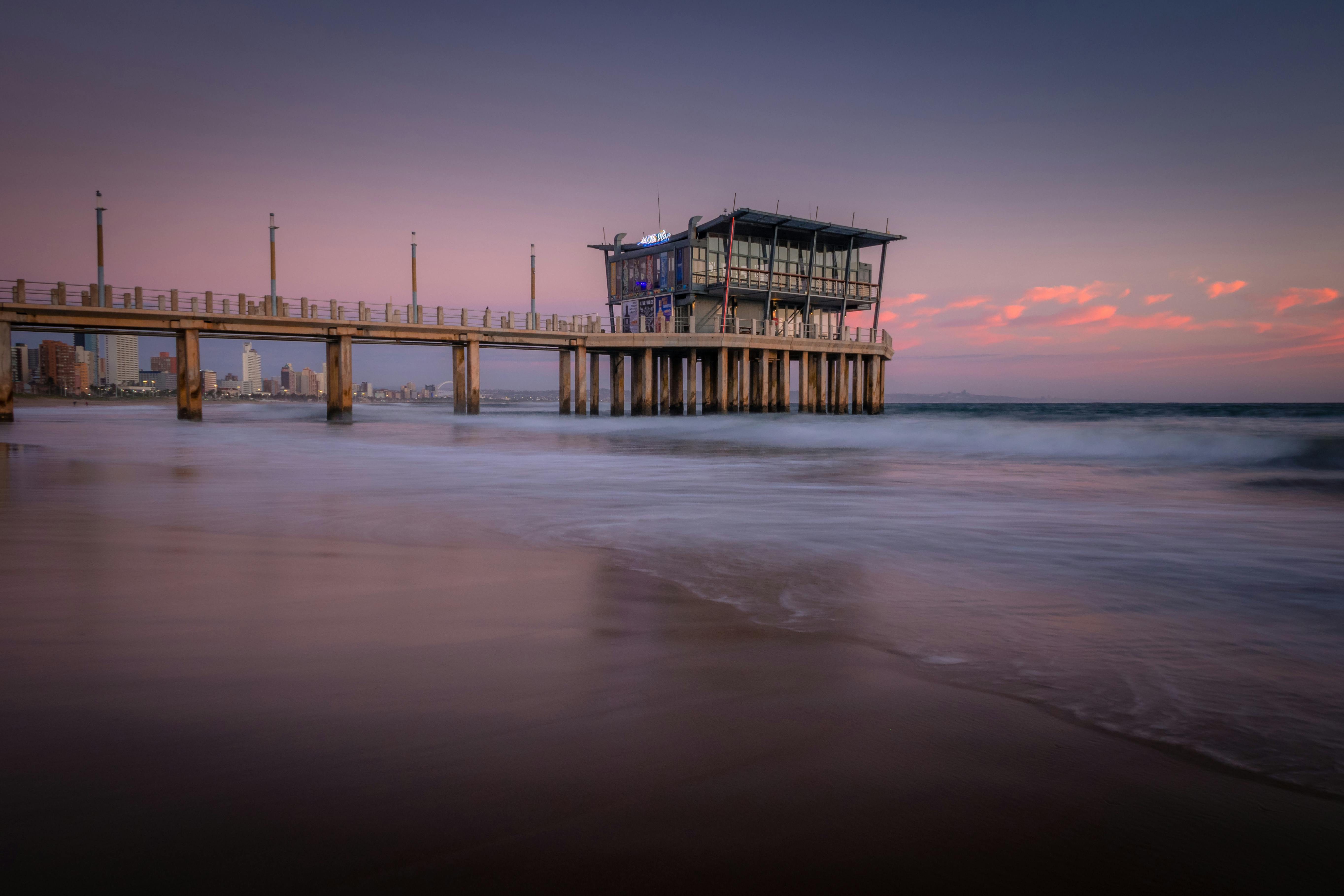 Building on Pier in Water on Sunset · Free Stock Photo