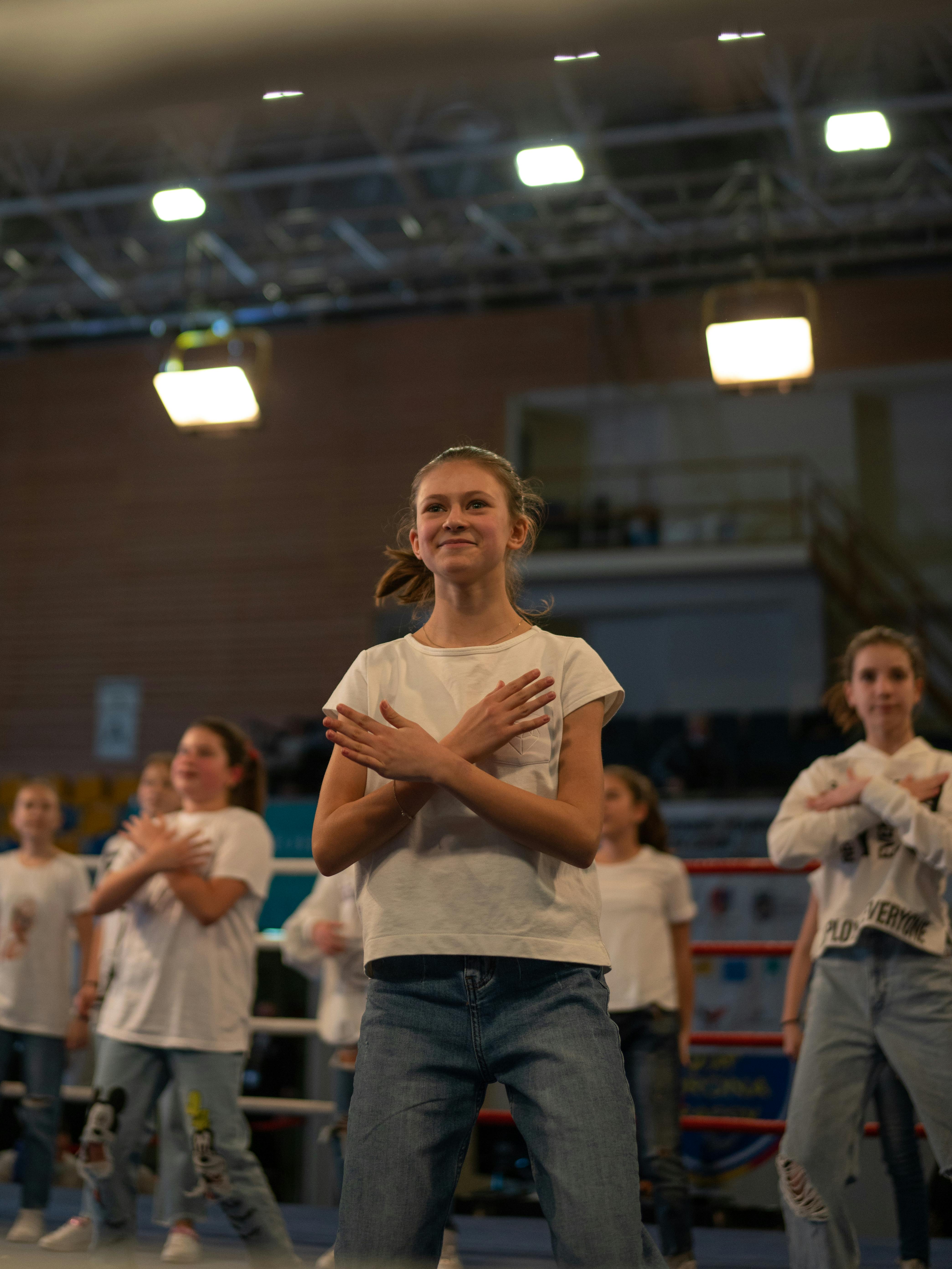 Photograph of Cheerleaders Sitting on a White Floor · Free Stock Photo