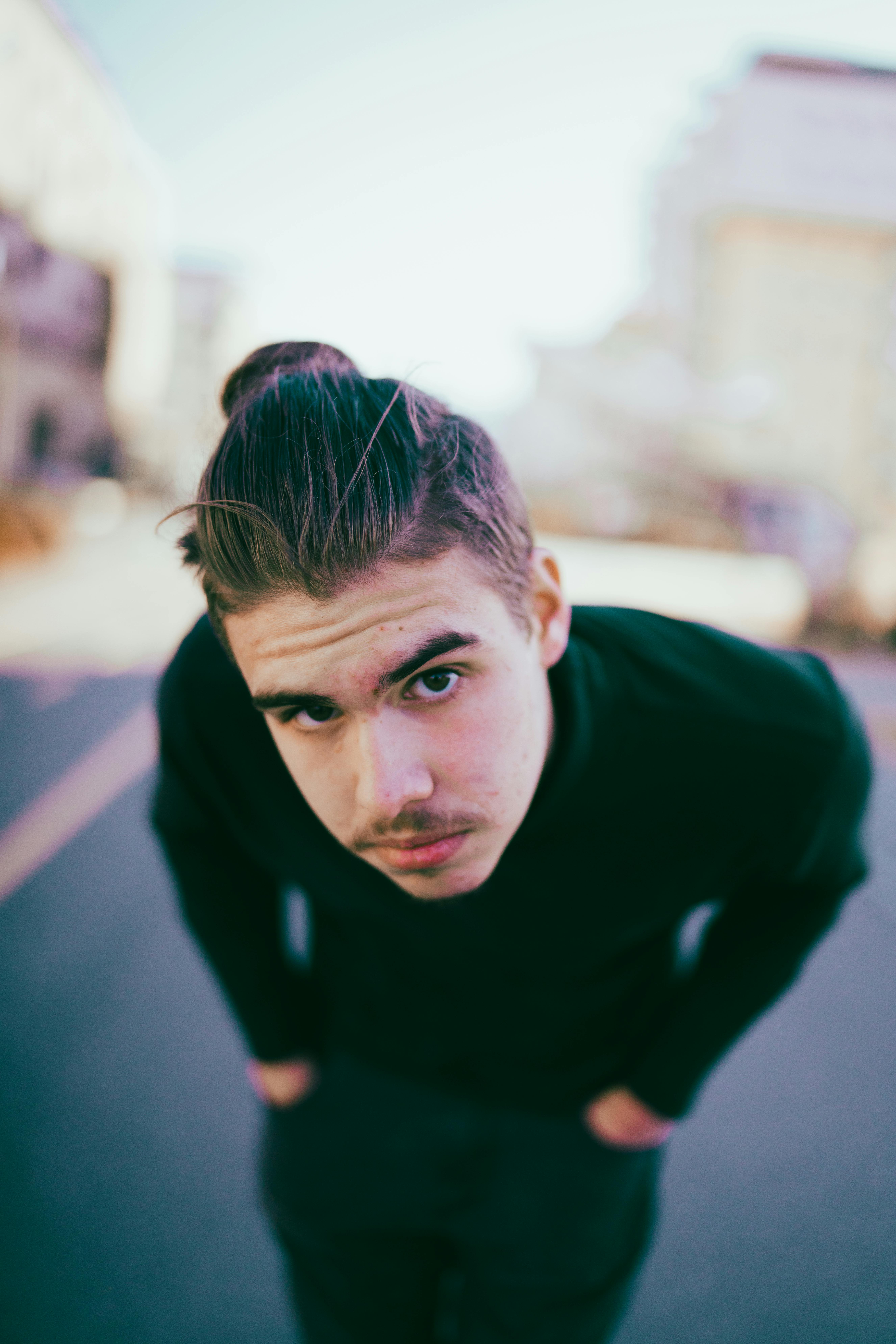 A Man Leaning Forward with His Hands Together · Free Stock Photo