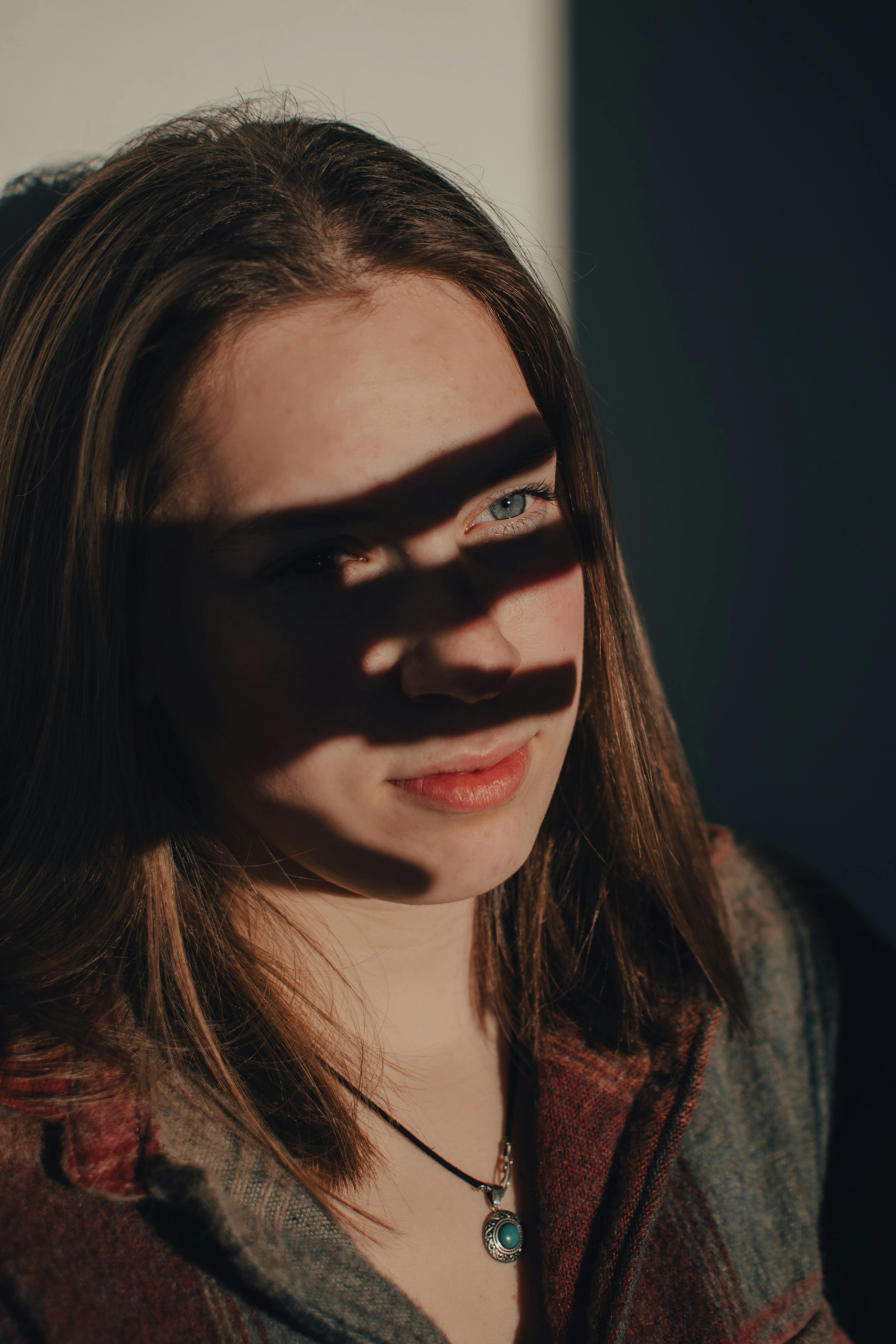 A Portrait of a Woman with Shadow on Her Face · Free Stock Photo
