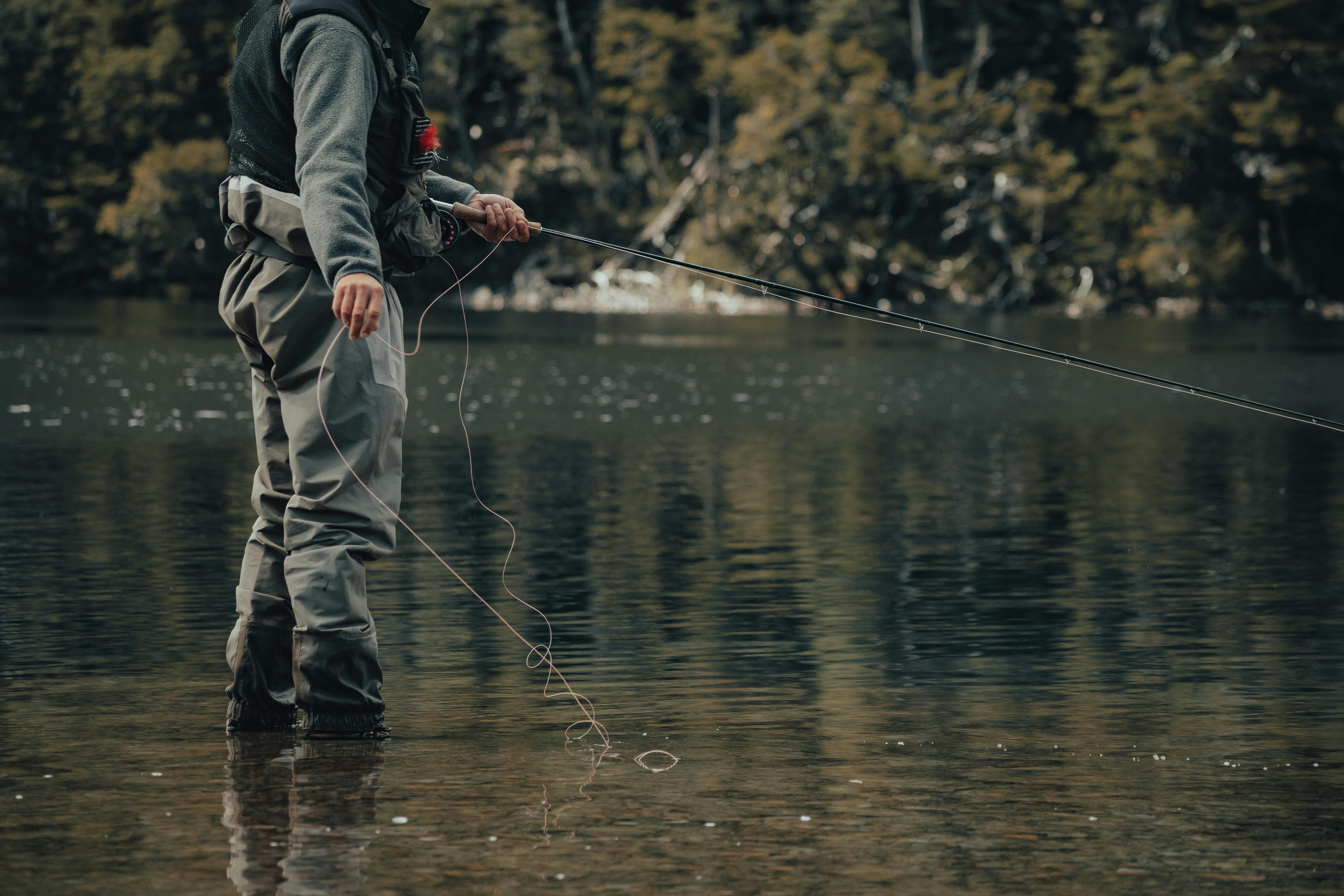 Person on White Boat Fishing on Body of Water · Free Stock Photo