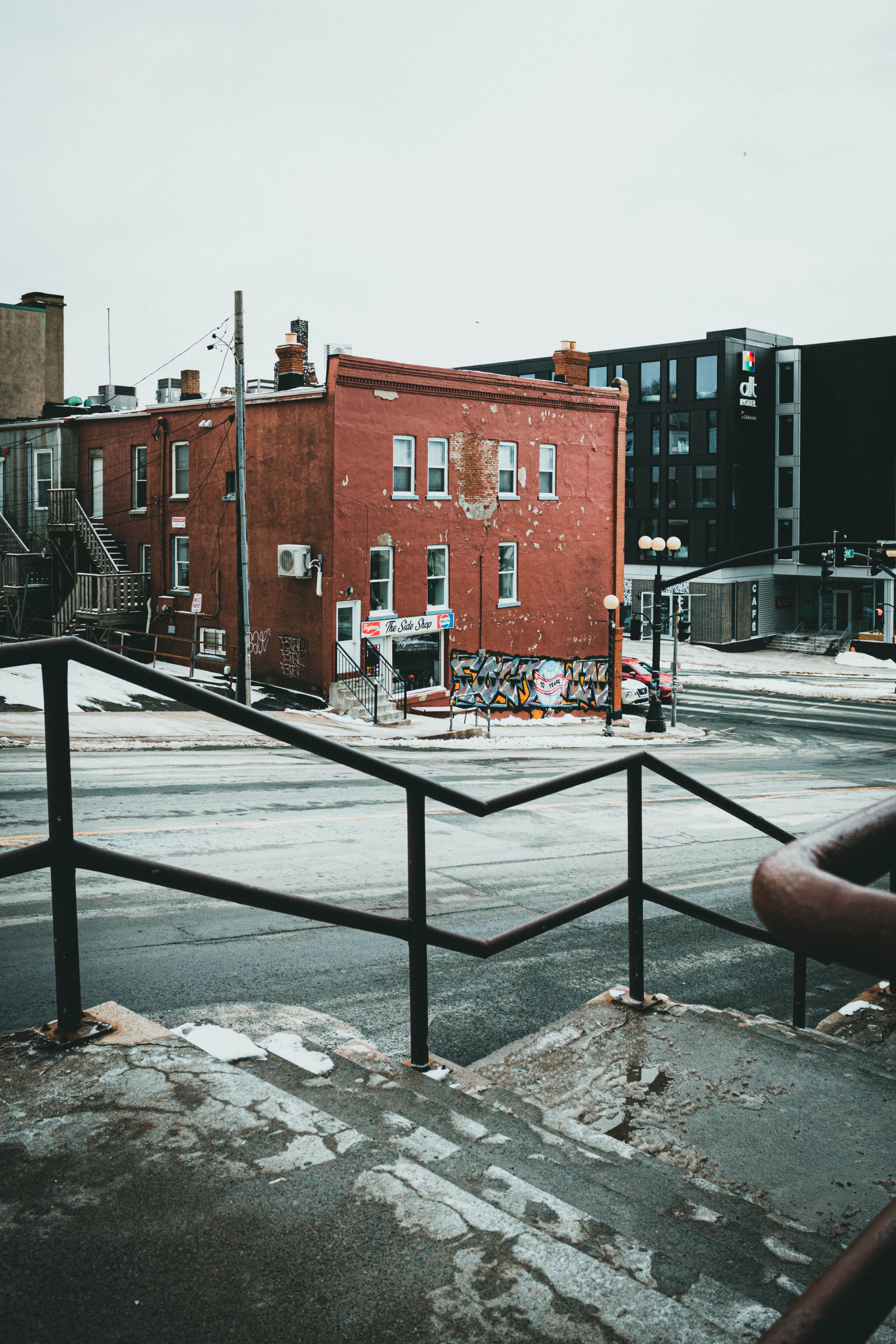 Brown Brick Building Near the Road · Free Stock Photo