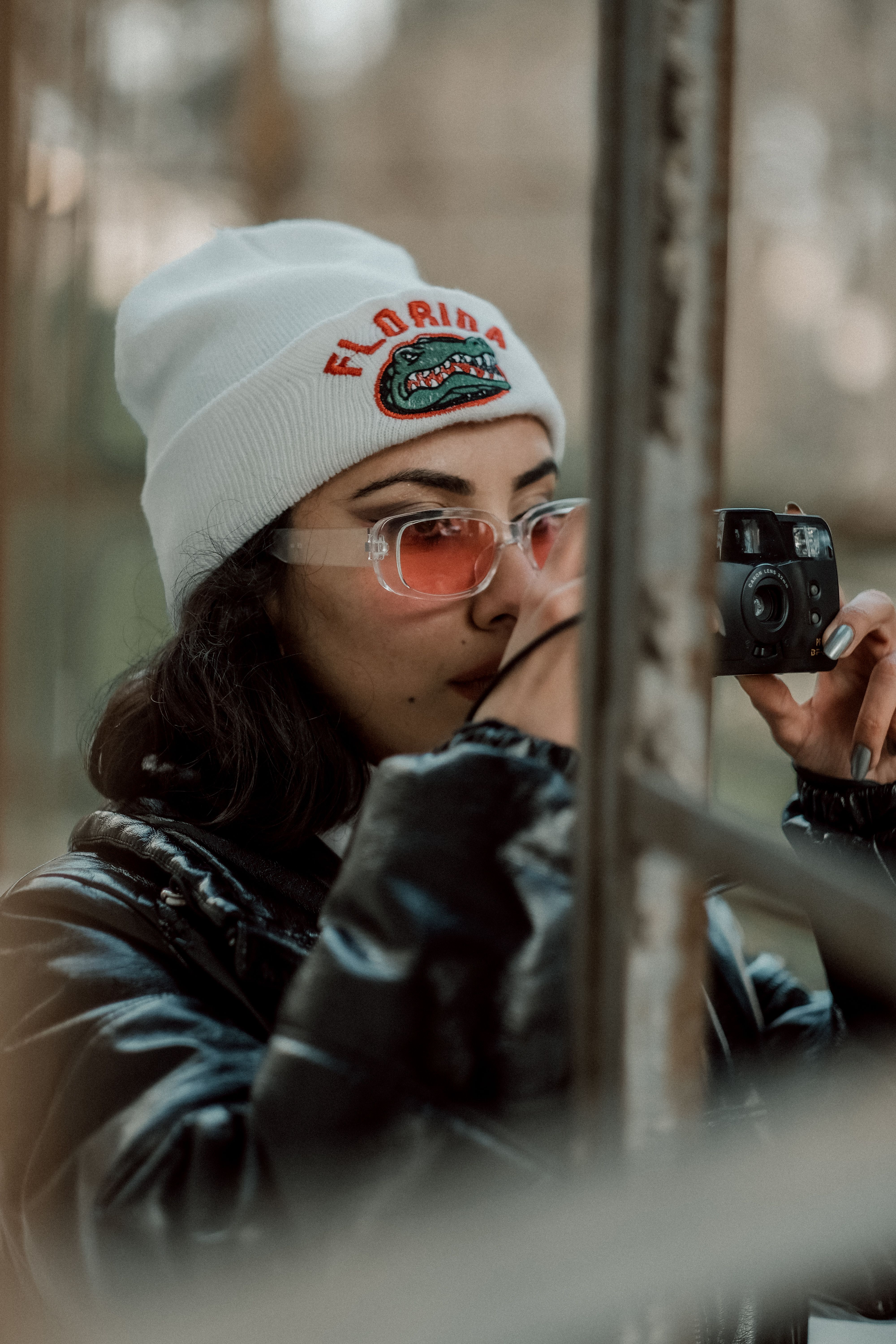 A Woman Wearing Beanie While Using Camera · Free Stock Photo